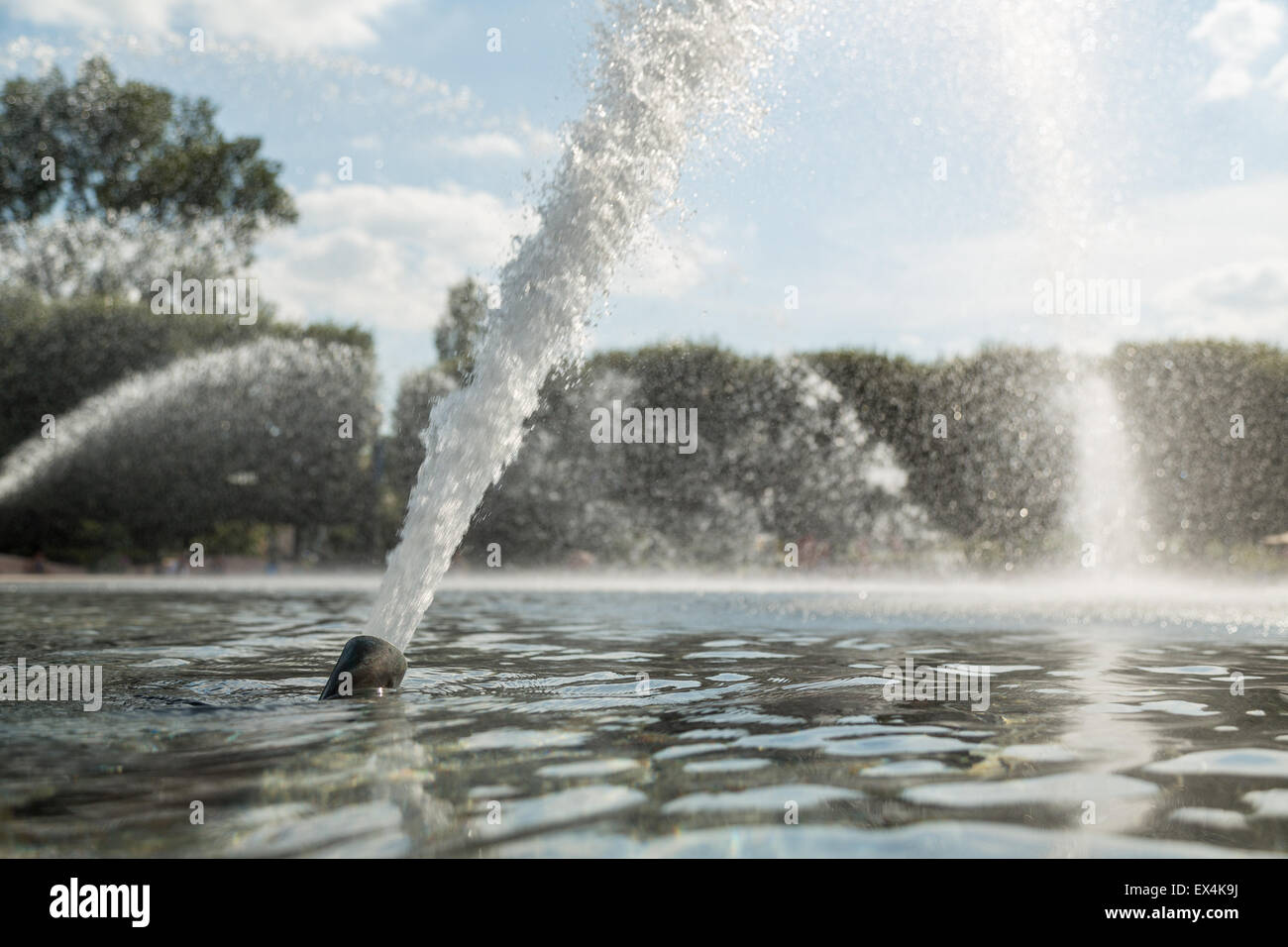 High pressured water gushing out of a pipe in a fountain Stock Photo ...