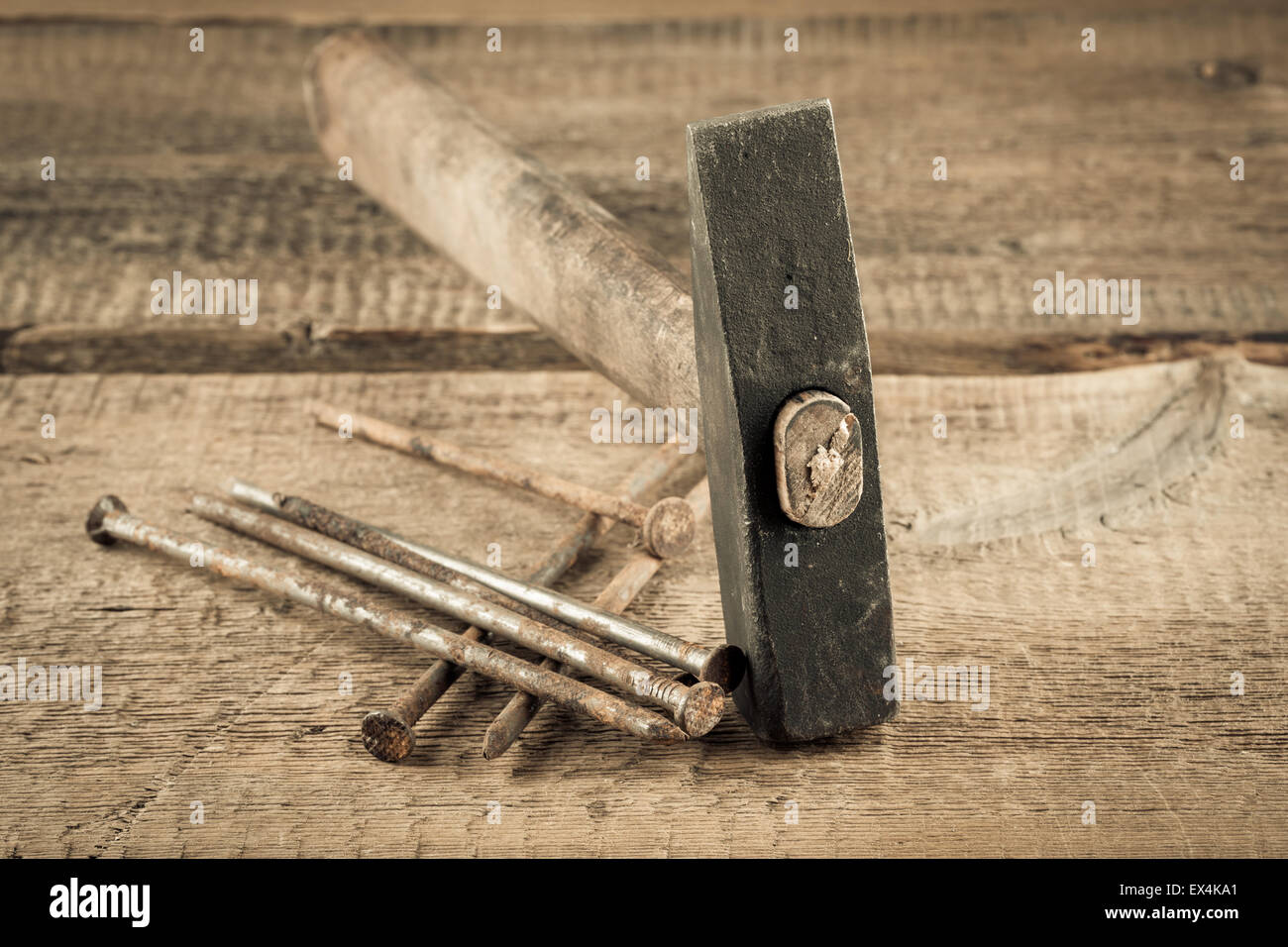 Vintage old hammer with rusty nails on wood table background Stock ...