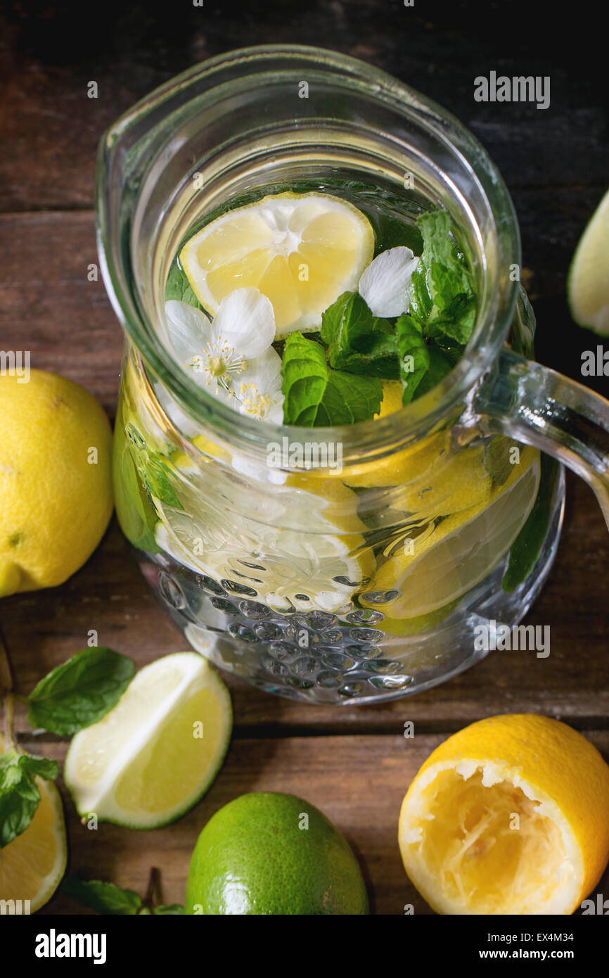 Glass pitcher of homemade lemonade, served with whole and sliced lemons ...