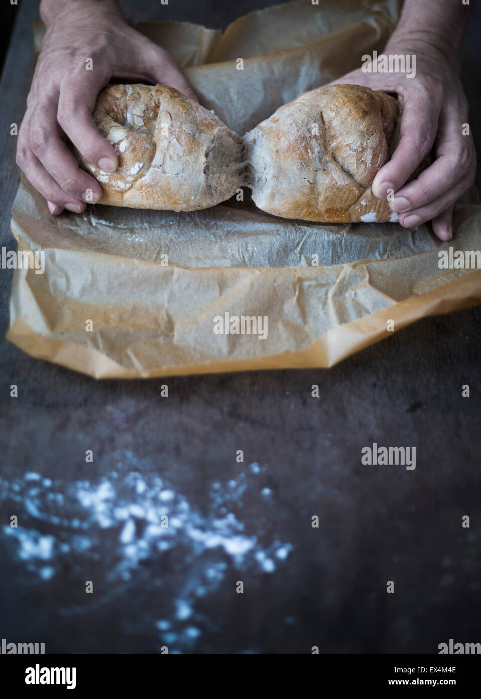 Breaking bread hands hi-res stock photography and images - Alamy