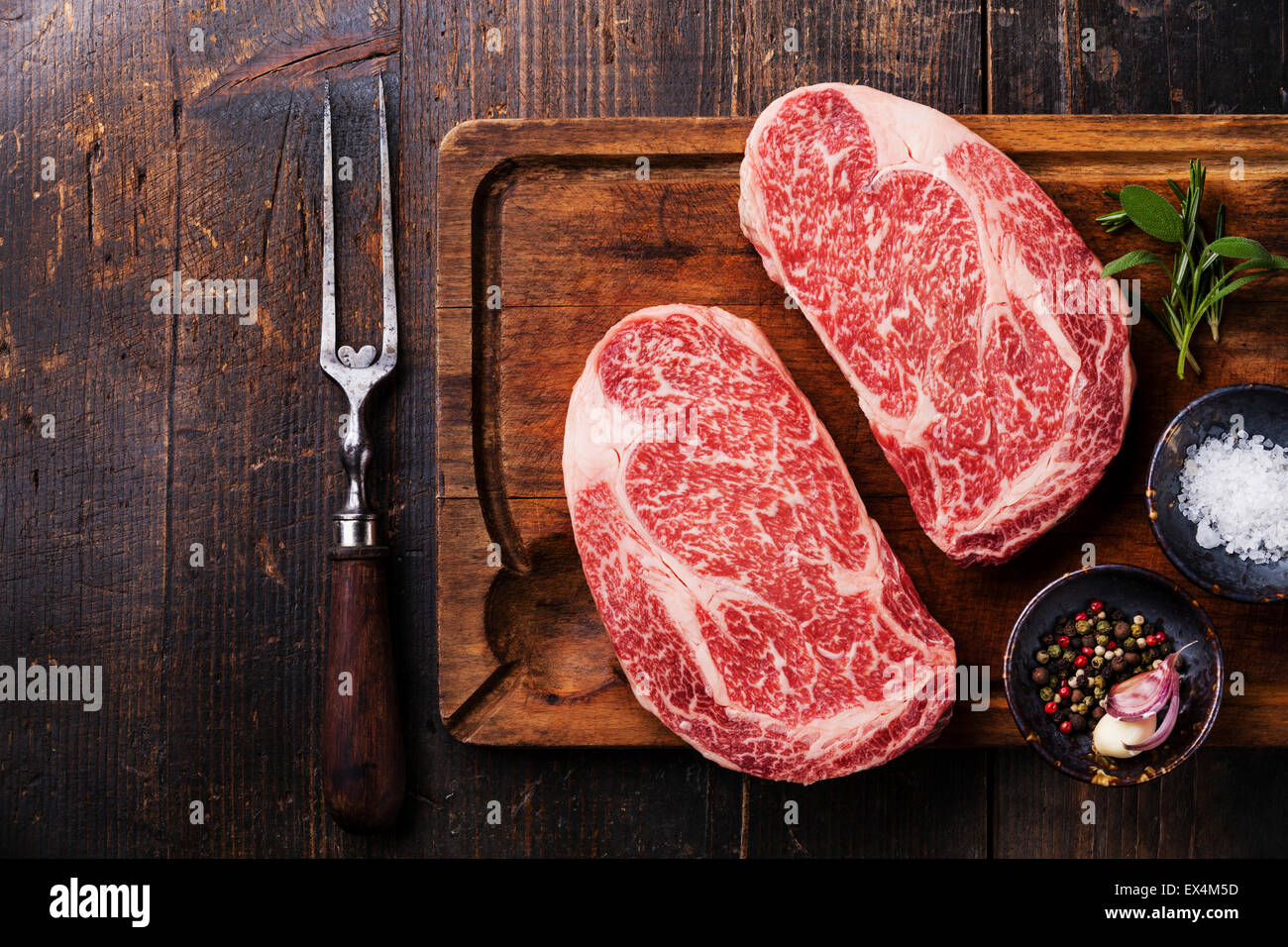 Two Raw fresh marbled meat Black Angus Steak Ribeye, seasonings and ...