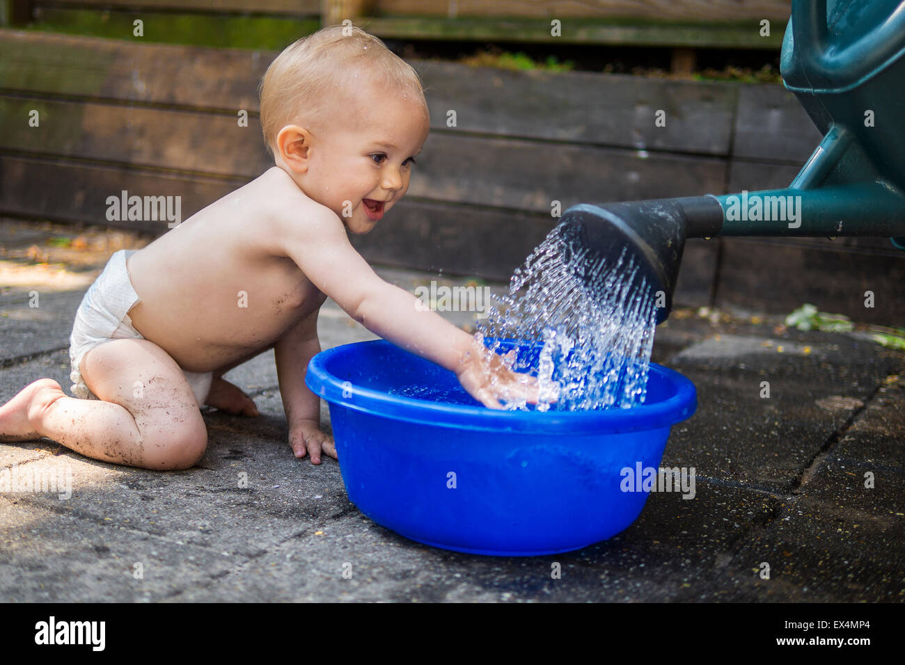 adorable baby playing with water outdoors Stock Photo - Alamy