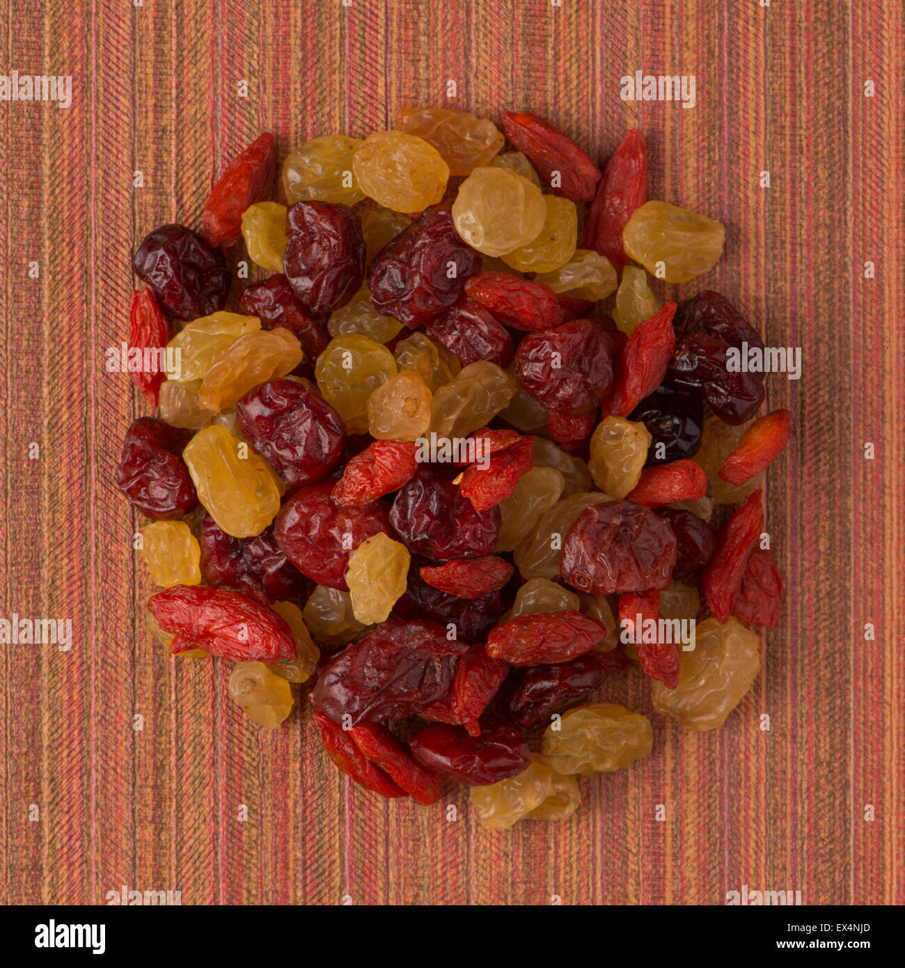Top view of circle of mixed dried fruits against red vinyl background ...
