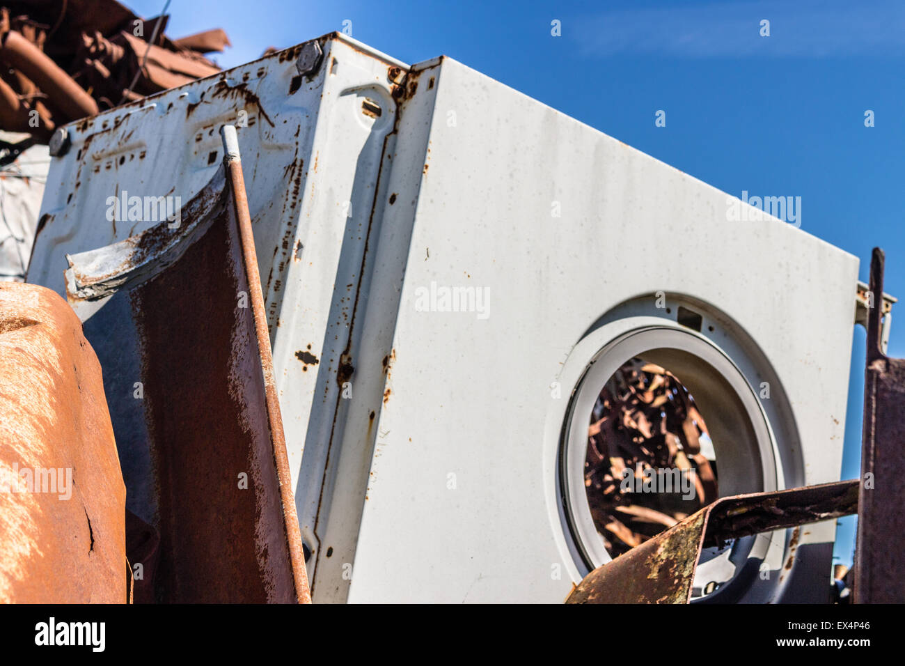 a chaotic collection of ferrous rusty with a washing machine reminds of ...