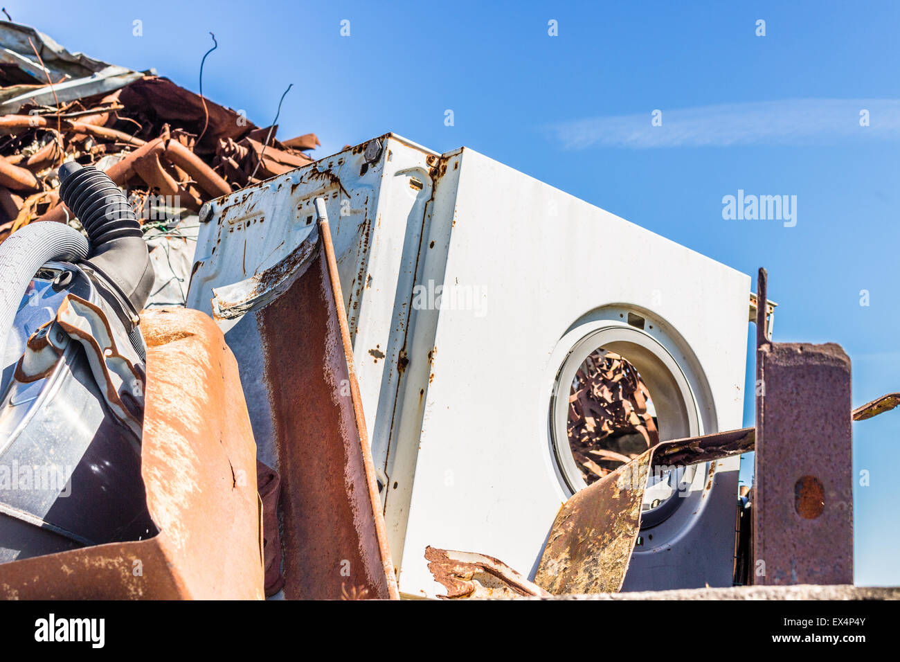 a chaotic collection of ferrous rusty with a washing machine reminds of ...
