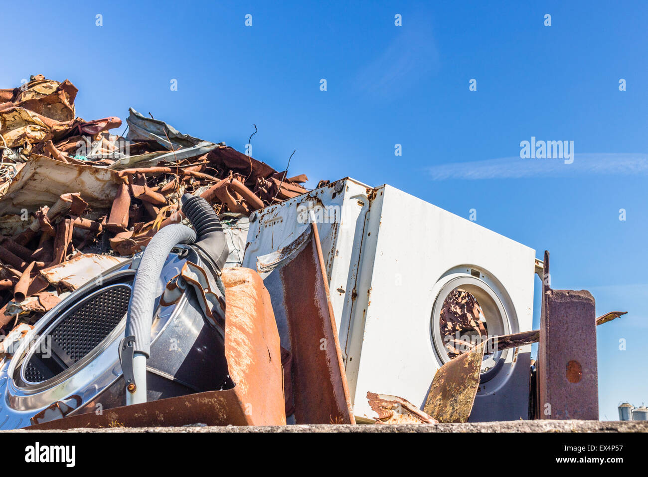 a chaotic collection of ferrous rusty with a washing machine reminds of ...
