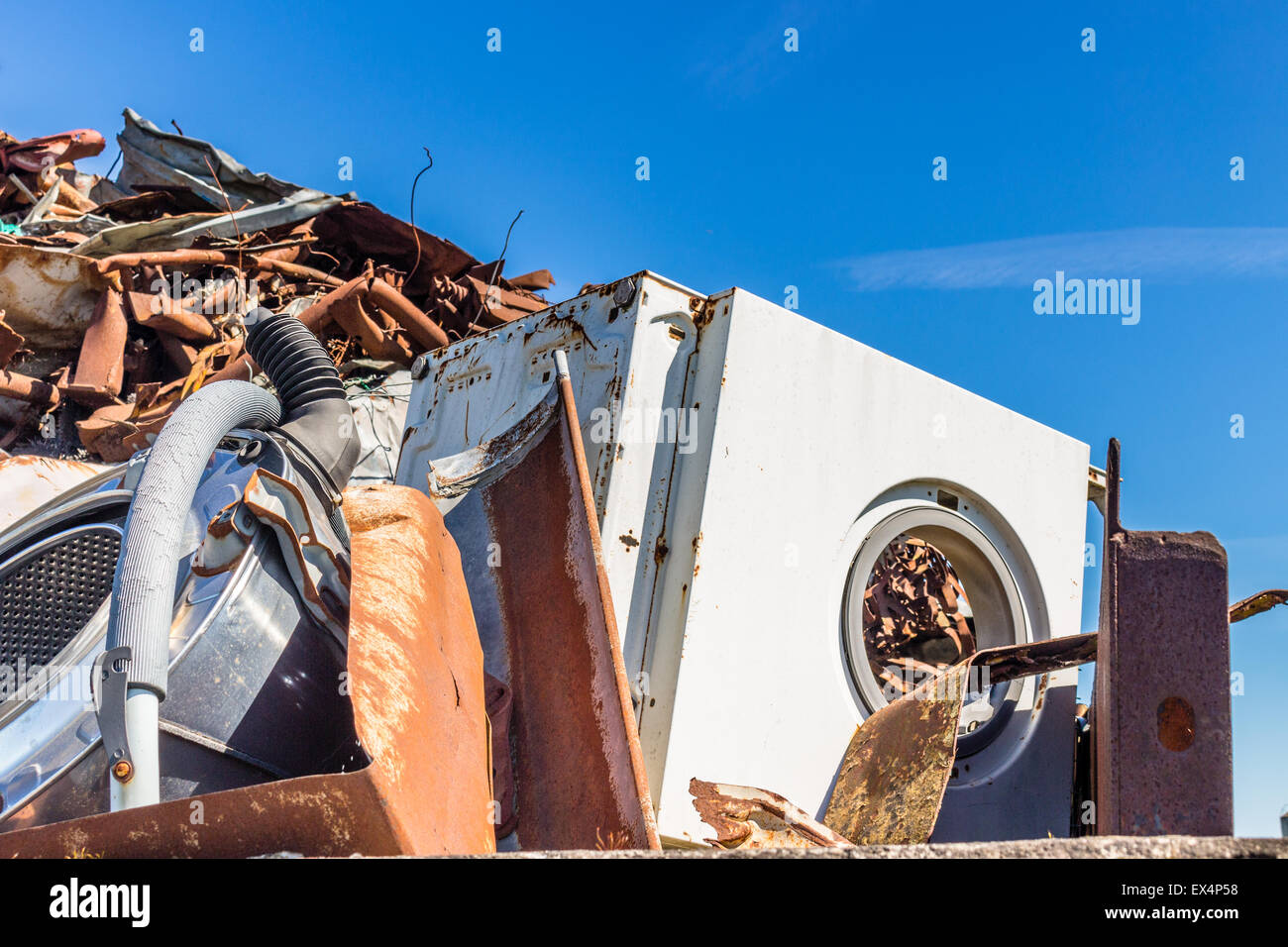a chaotic collection of ferrous rusty with a washing machine reminds of ...