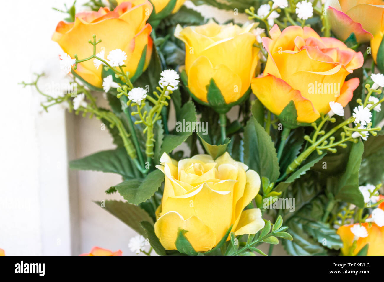 fake laminated paper flowers in a cemetery Stock Photo - Alamy