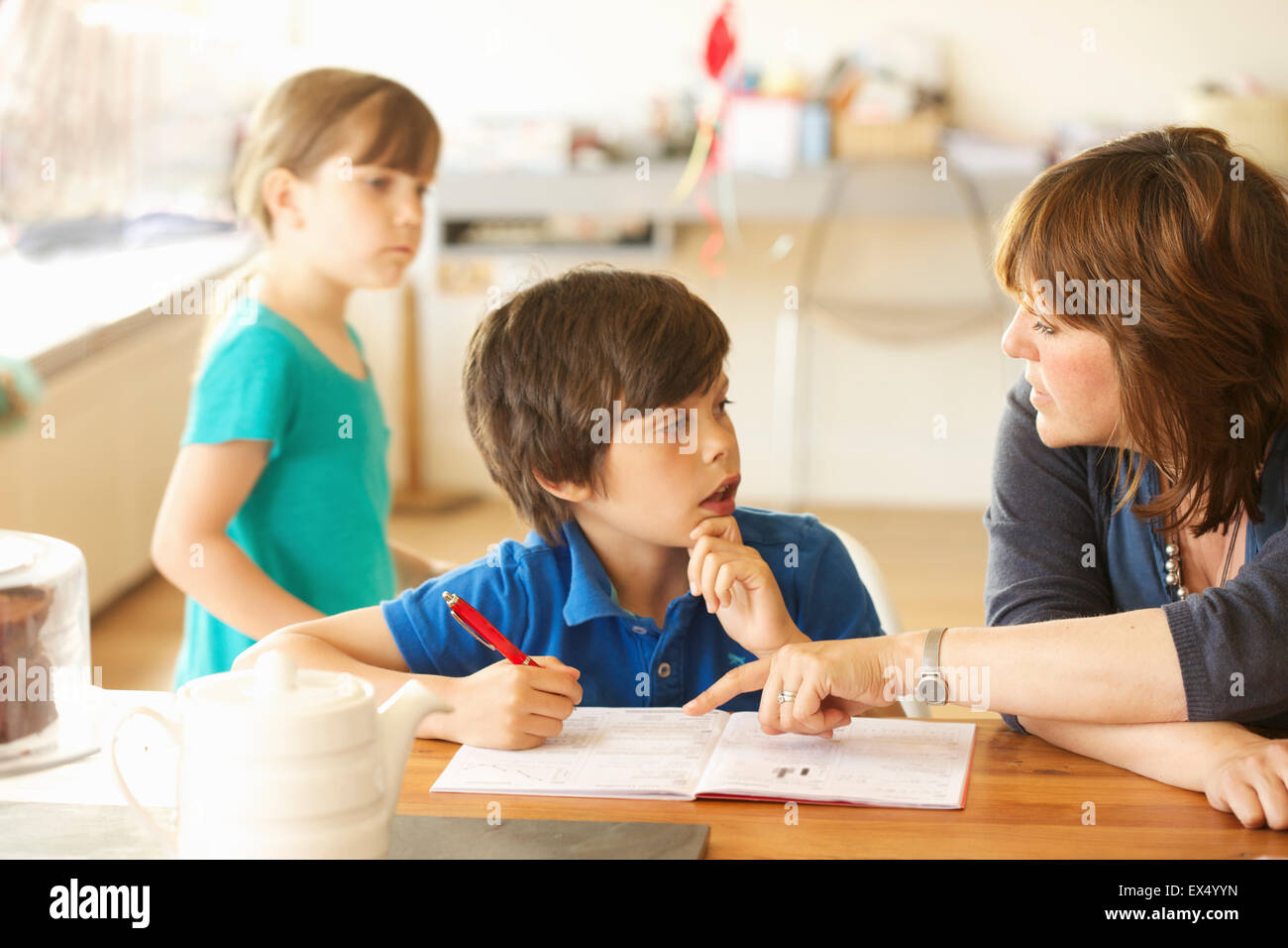 Boy and girl homework kitchen table hi-res stock photography and images ...