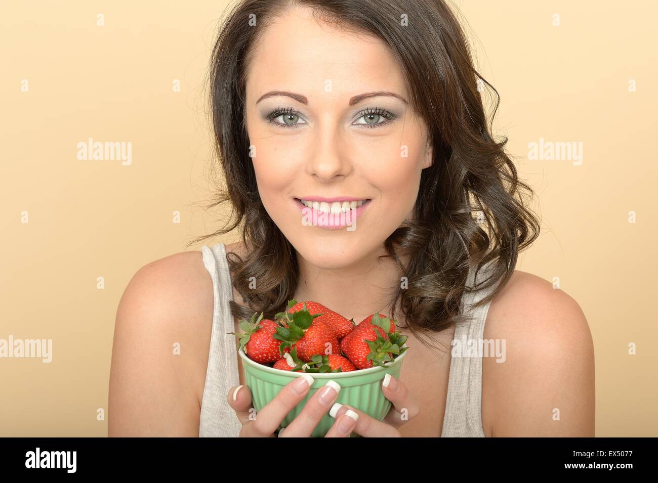 Attractive Beautiful Young Woman Looking at the Camera Eating Fresh ...