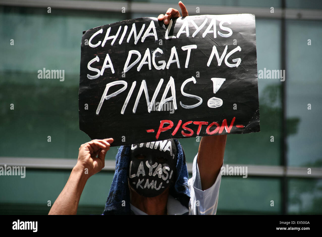 A protester in front of the Chinese embassy in Makati CIty, holds a ...