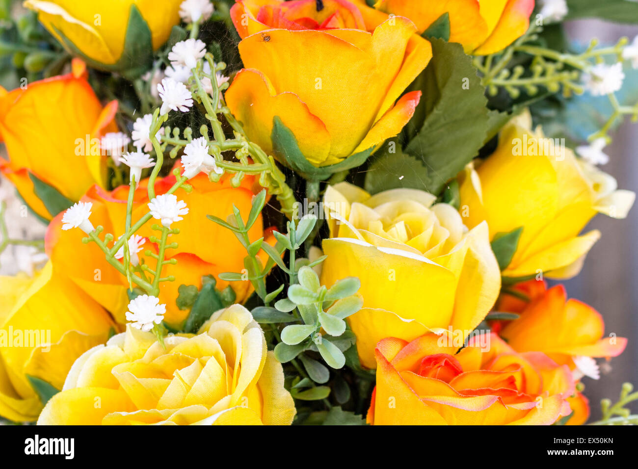 fake laminated paper flowers in a cemetery Stock Photo - Alamy