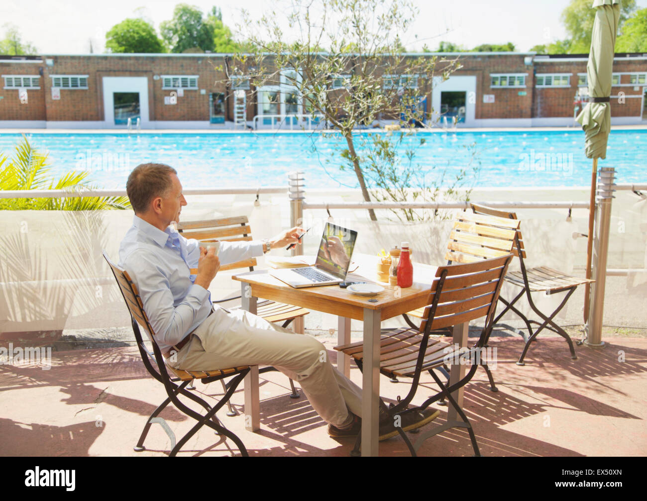 Man with laptop pool hi-res stock photography and images - Alamy
