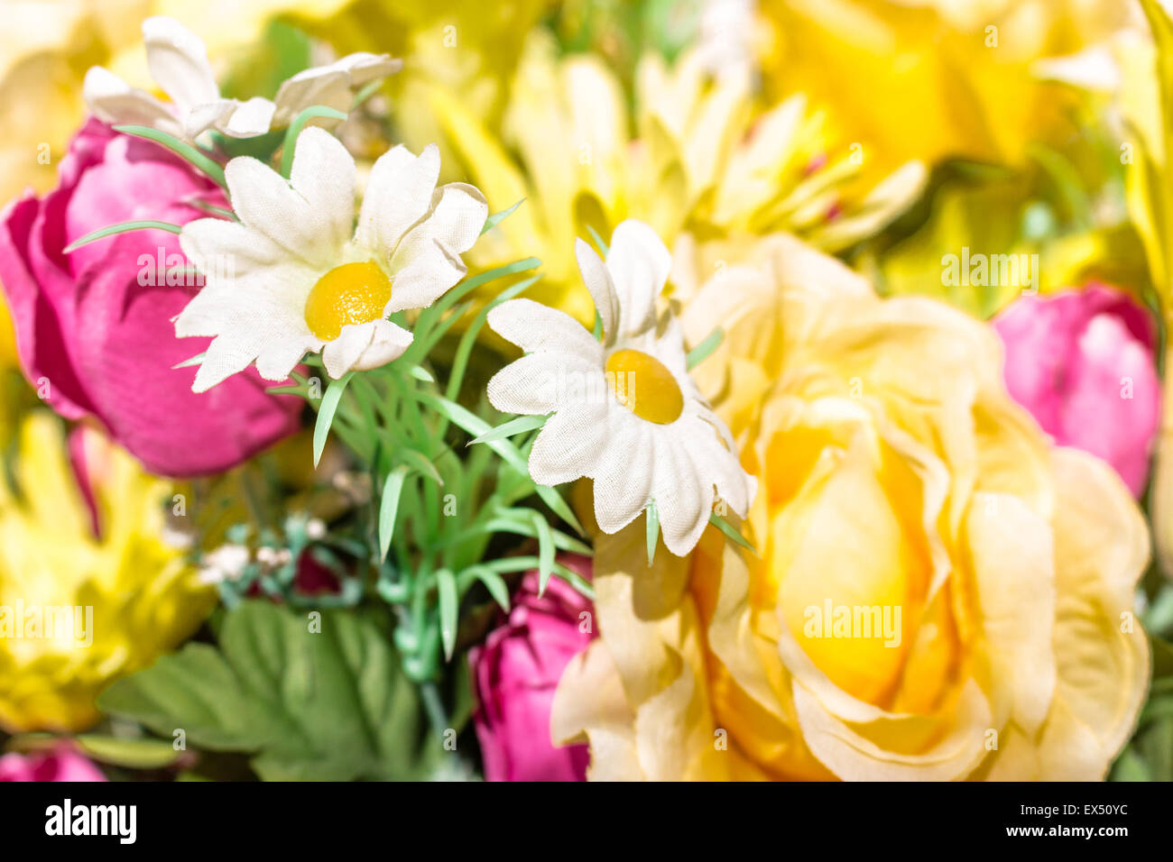 fake laminated paper flowers in a cemetery Stock Photo - Alamy