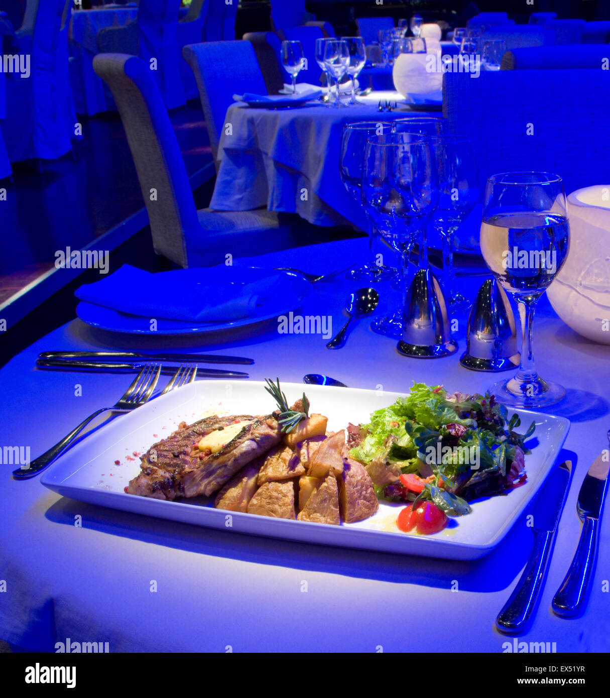 Stake main course serving suggestion lit by architectural interior ...