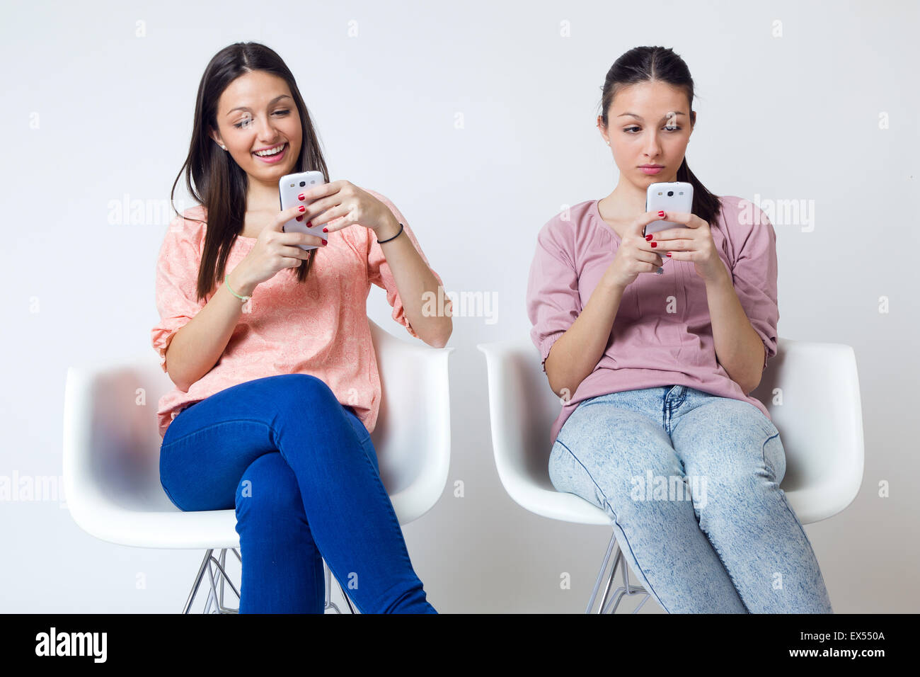 Portrait of beautiful young woman using her mobile phone at home Stock ...