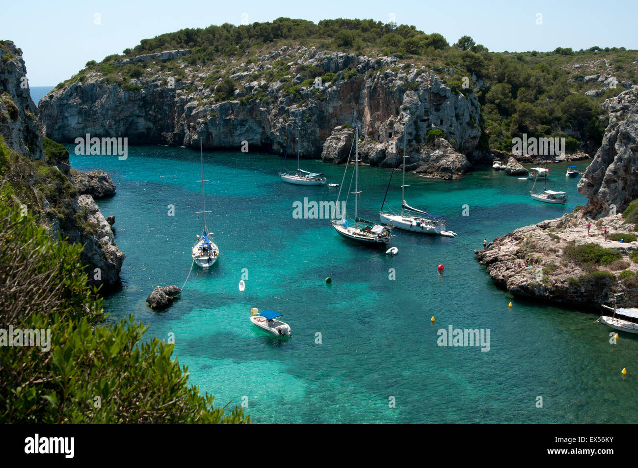 Sailing yachts moored in the secluded rocky cove of Calas Coves on the ...