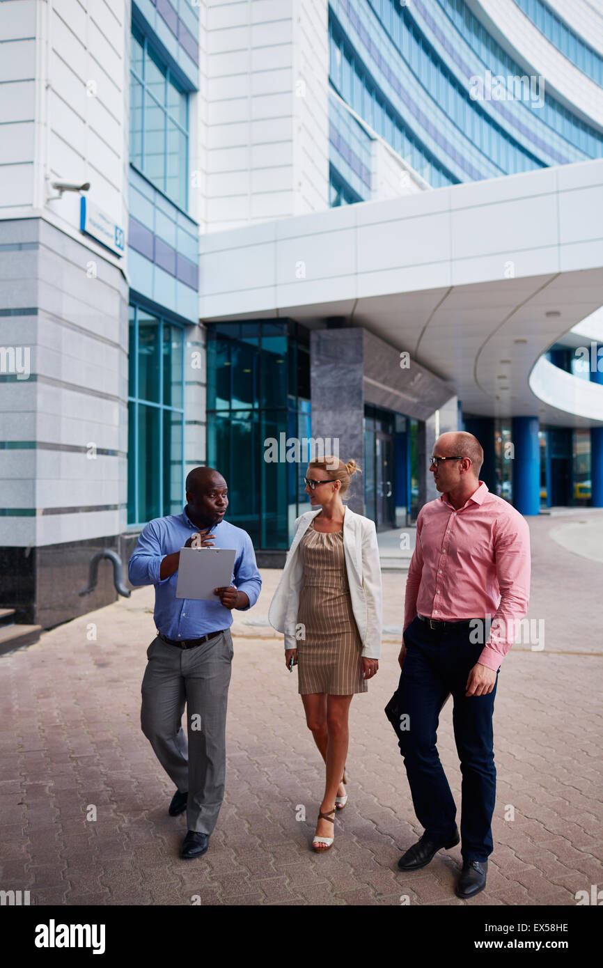 Business people interacting while walking by office building Stock ...