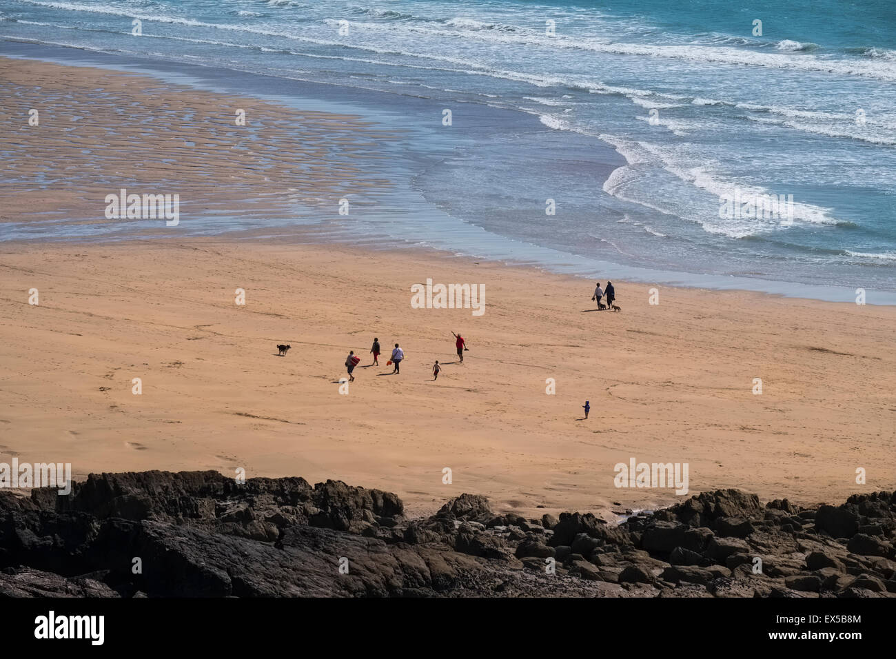 People walking on the beach along the Cornish coast at Bude, Cornwall ...