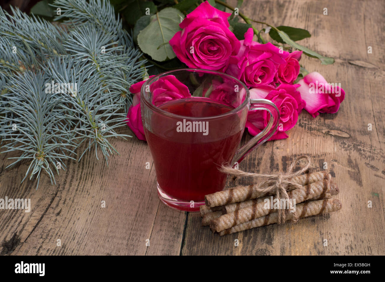 roses, a fir-tree branch and a mug of juice at center Stock Photo - Alamy