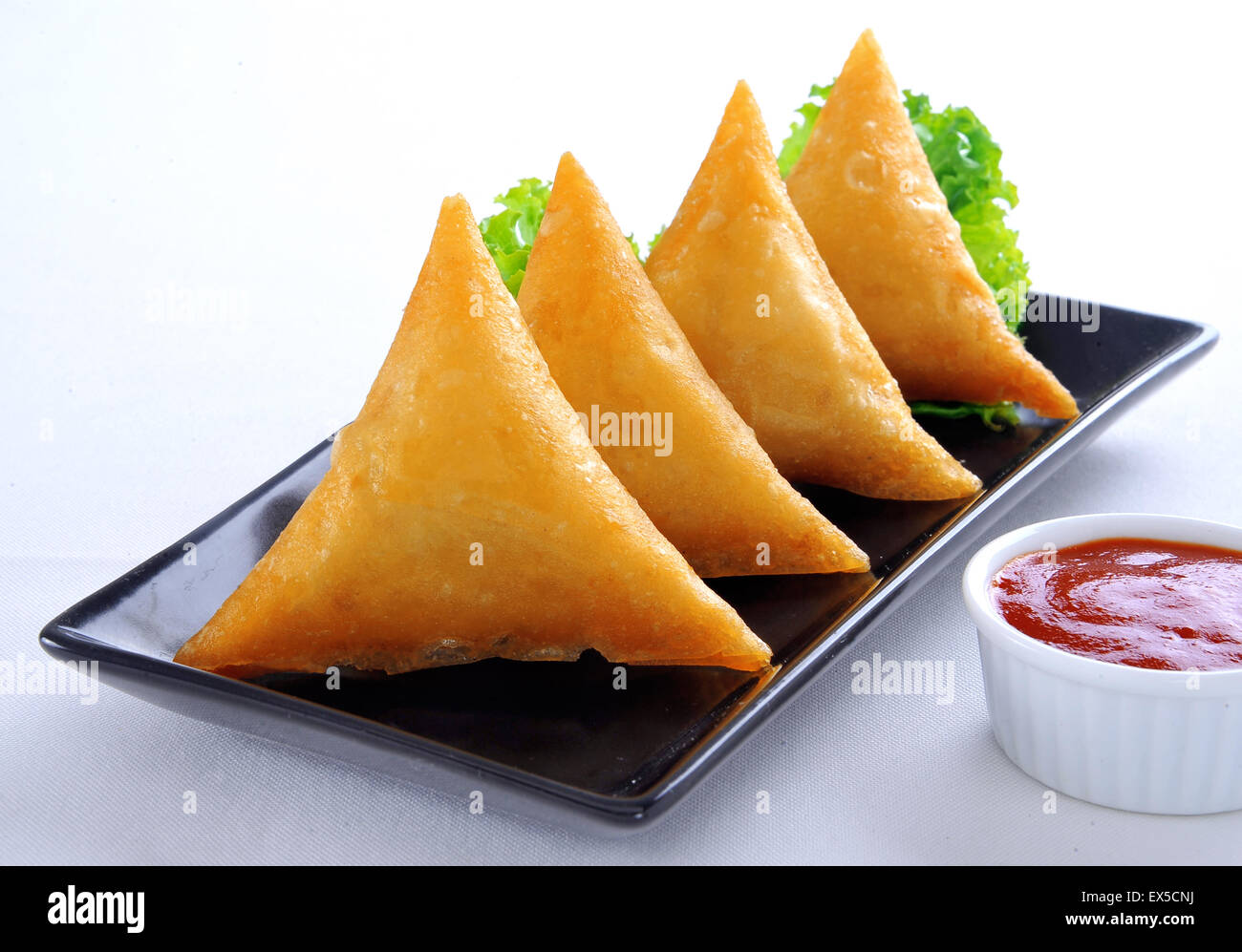 Beef Samosa in Black Dish Stock Photo - Alamy