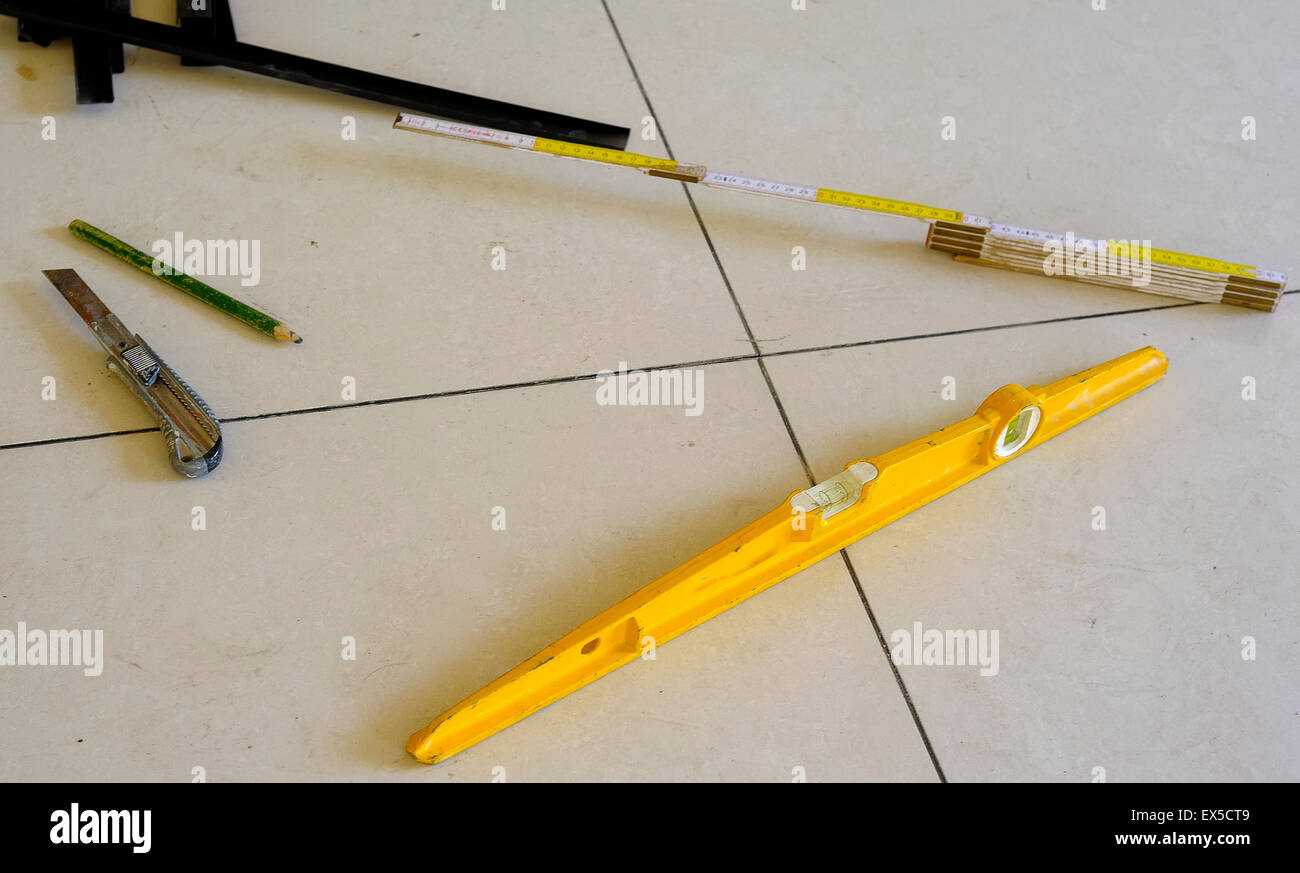 level, utility knife, strips, eec. tools work for a floating floor on ...