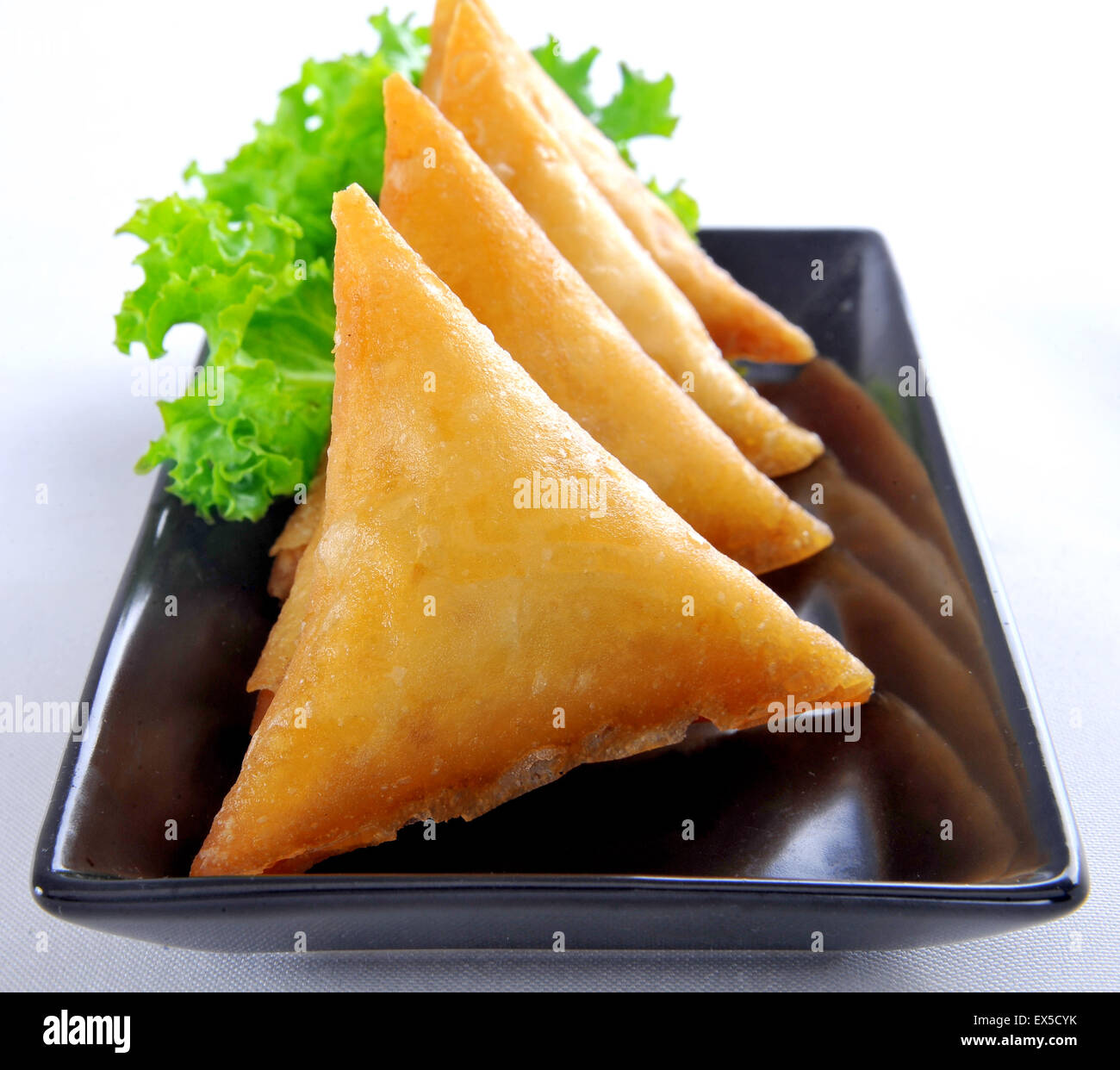 Beef Samosa in Black Dish Stock Photo - Alamy
