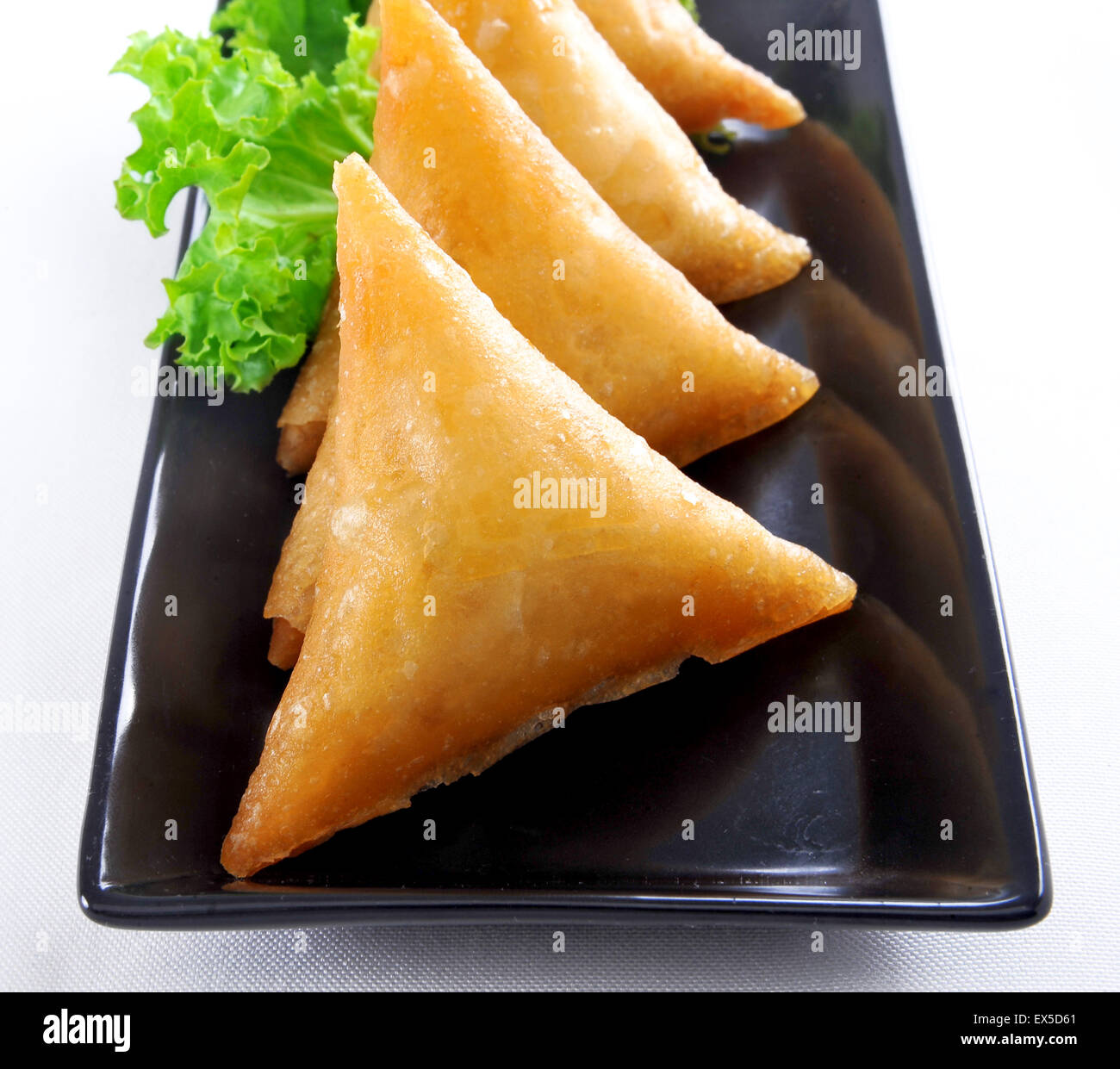 Beef Samosa in Black Dish Stock Photo - Alamy
