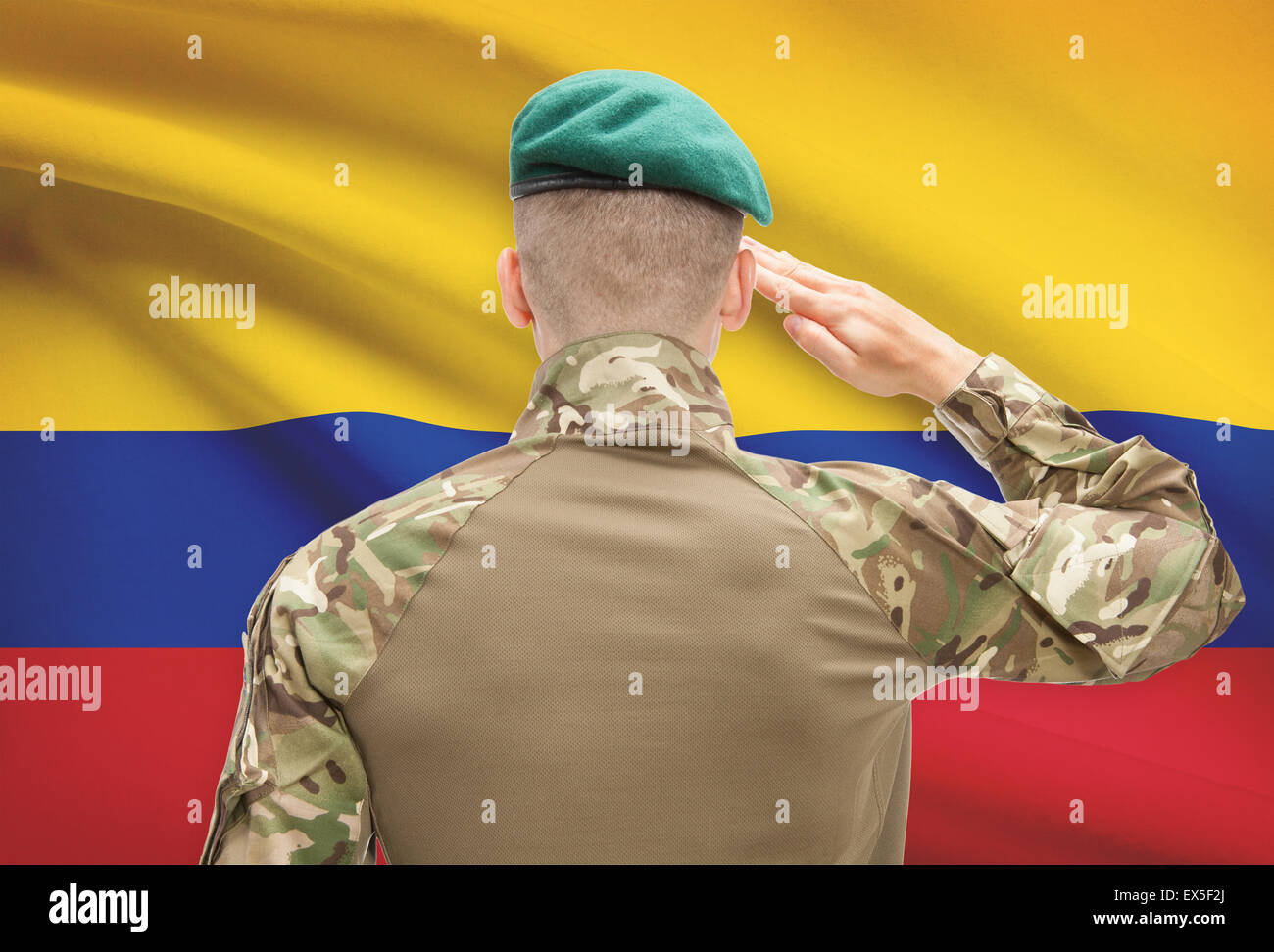 Soldier in hat facing national flag series - Colombia Stock Photo - Alamy