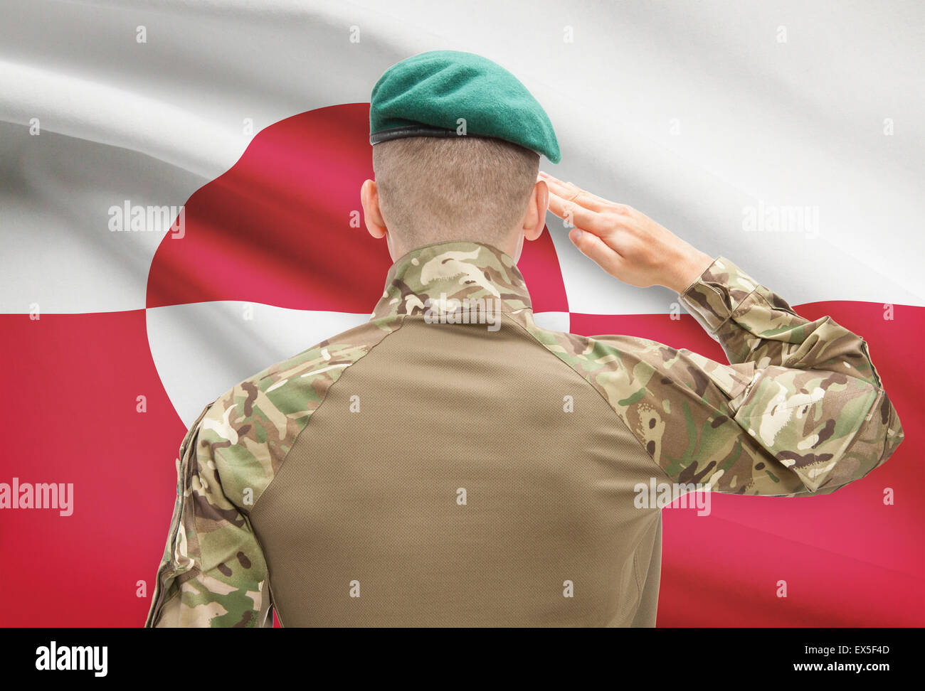 Soldier in hat facing national flag series - Greenland Stock Photo - Alamy