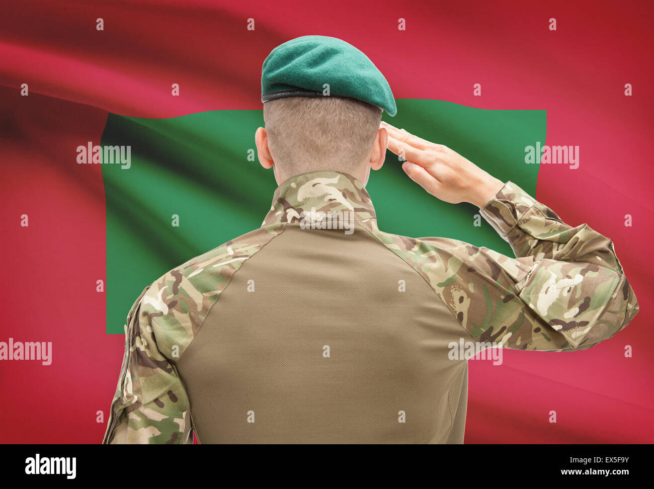 Soldier in hat facing national flag series - Maldives Stock Photo - Alamy