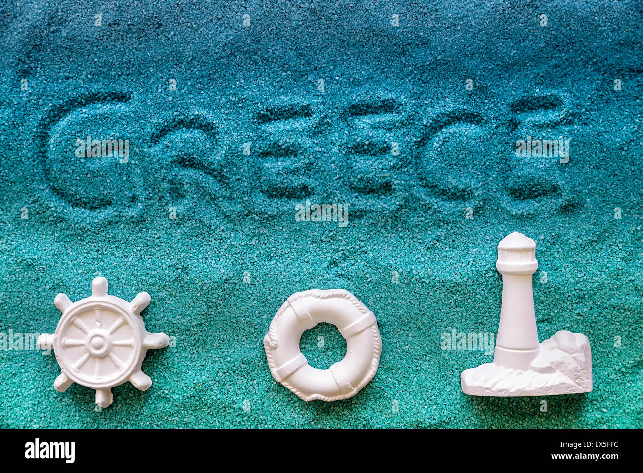 Greece written on the sand blue with summer symbol Stock Photo - Alamy