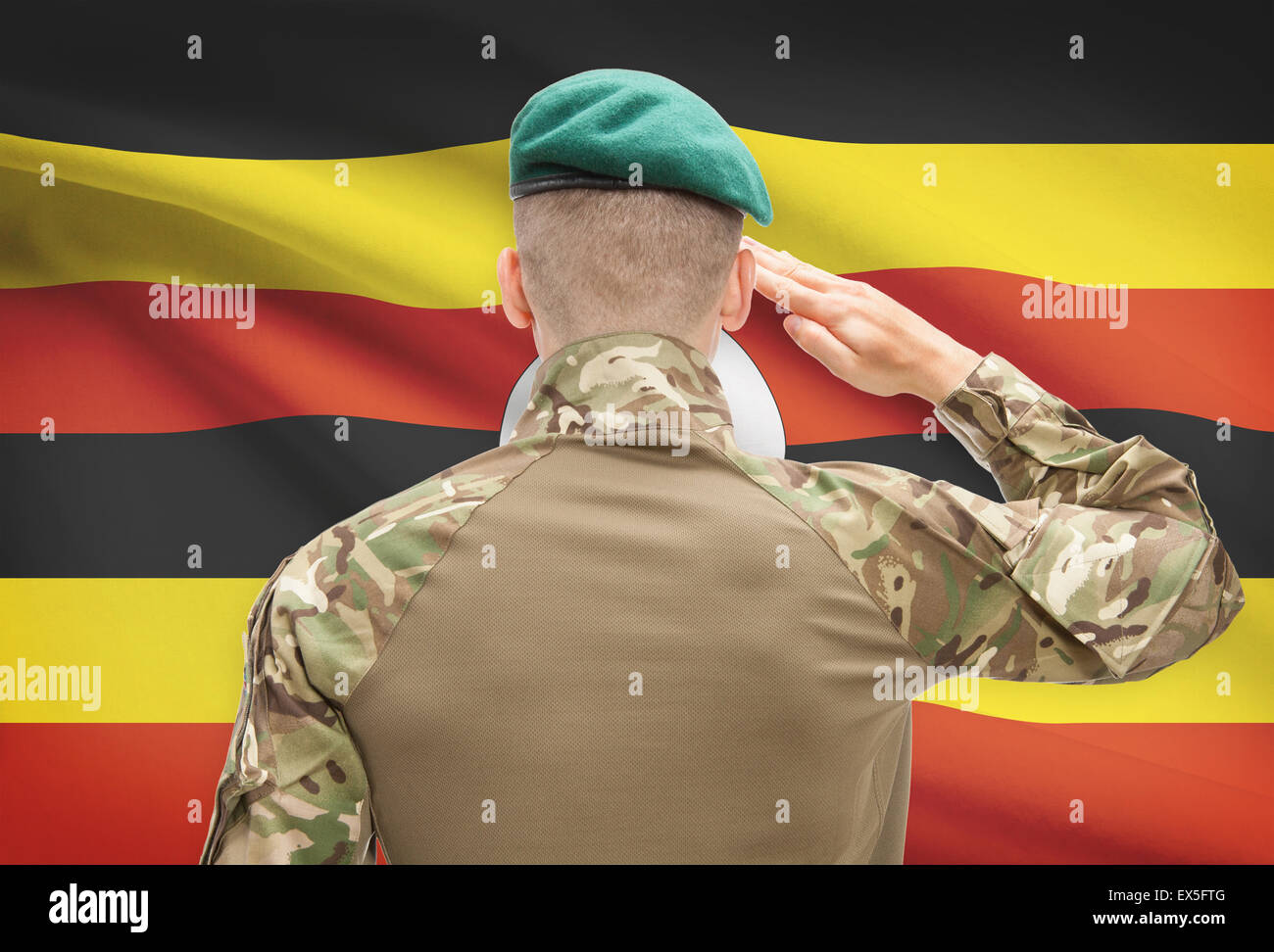 Soldier in hat facing national flag series - Uganda Stock Photo - Alamy