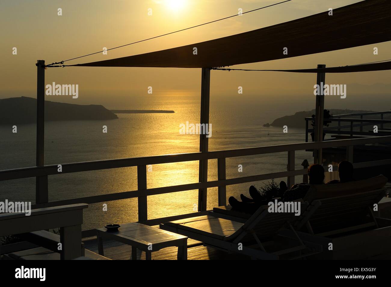 A sunset view from a hotel balcony in Santorini Greece Stock Photo - Alamy