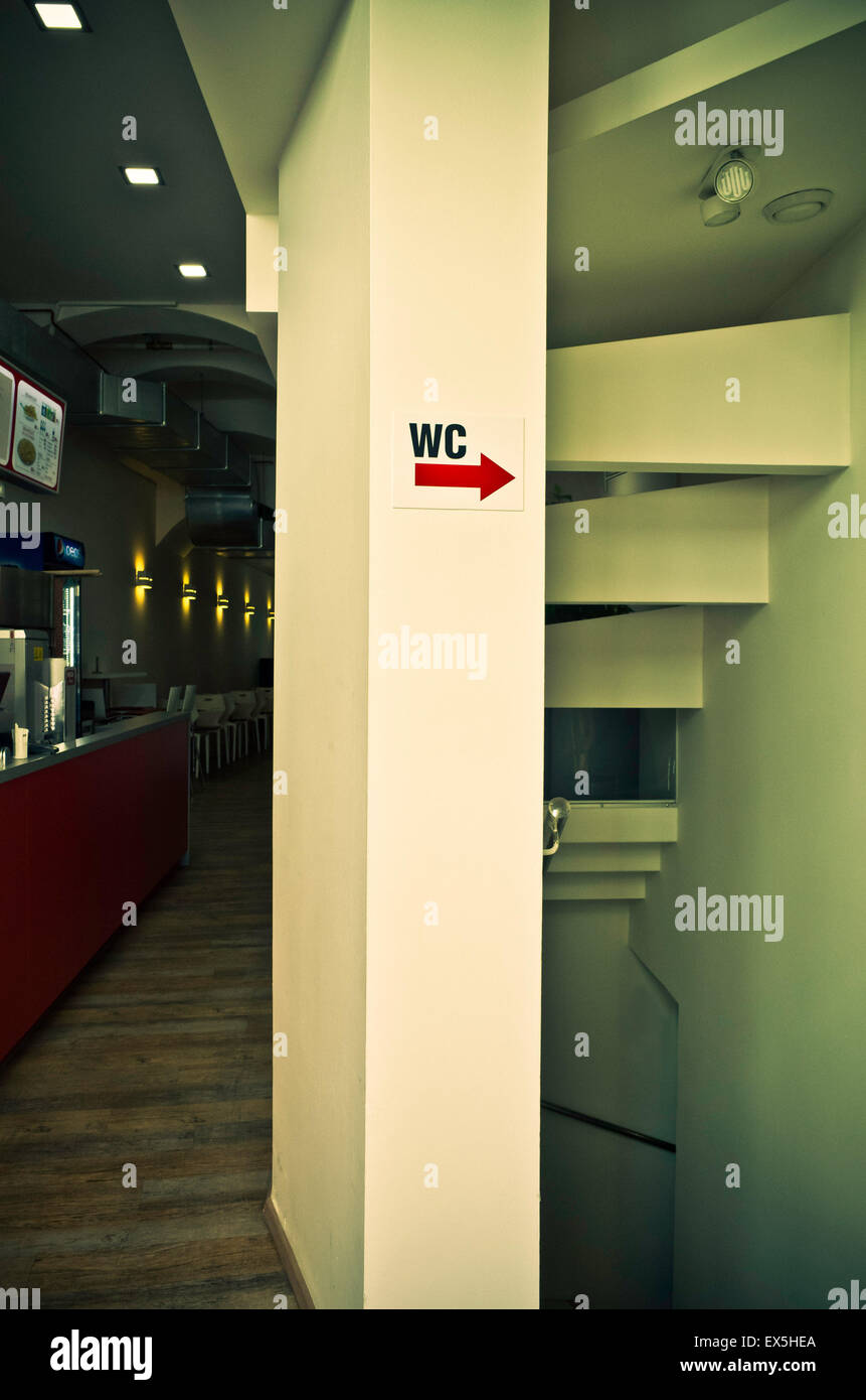 WC sign direction indication in a bar Stock Photo - Alamy