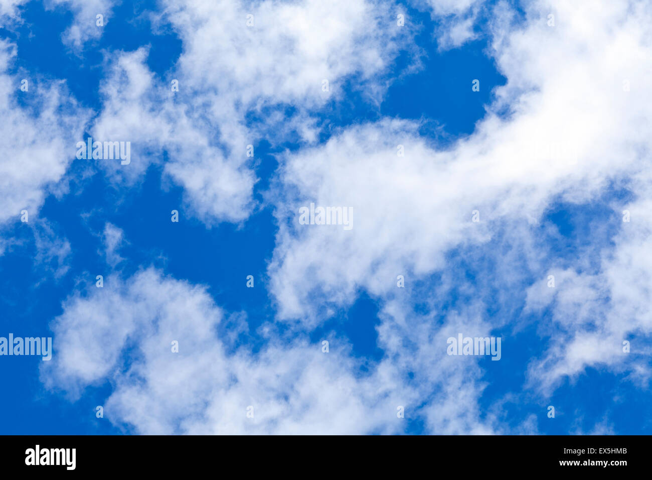 Blue sky and white background with aerial texture clouds in a distance ...