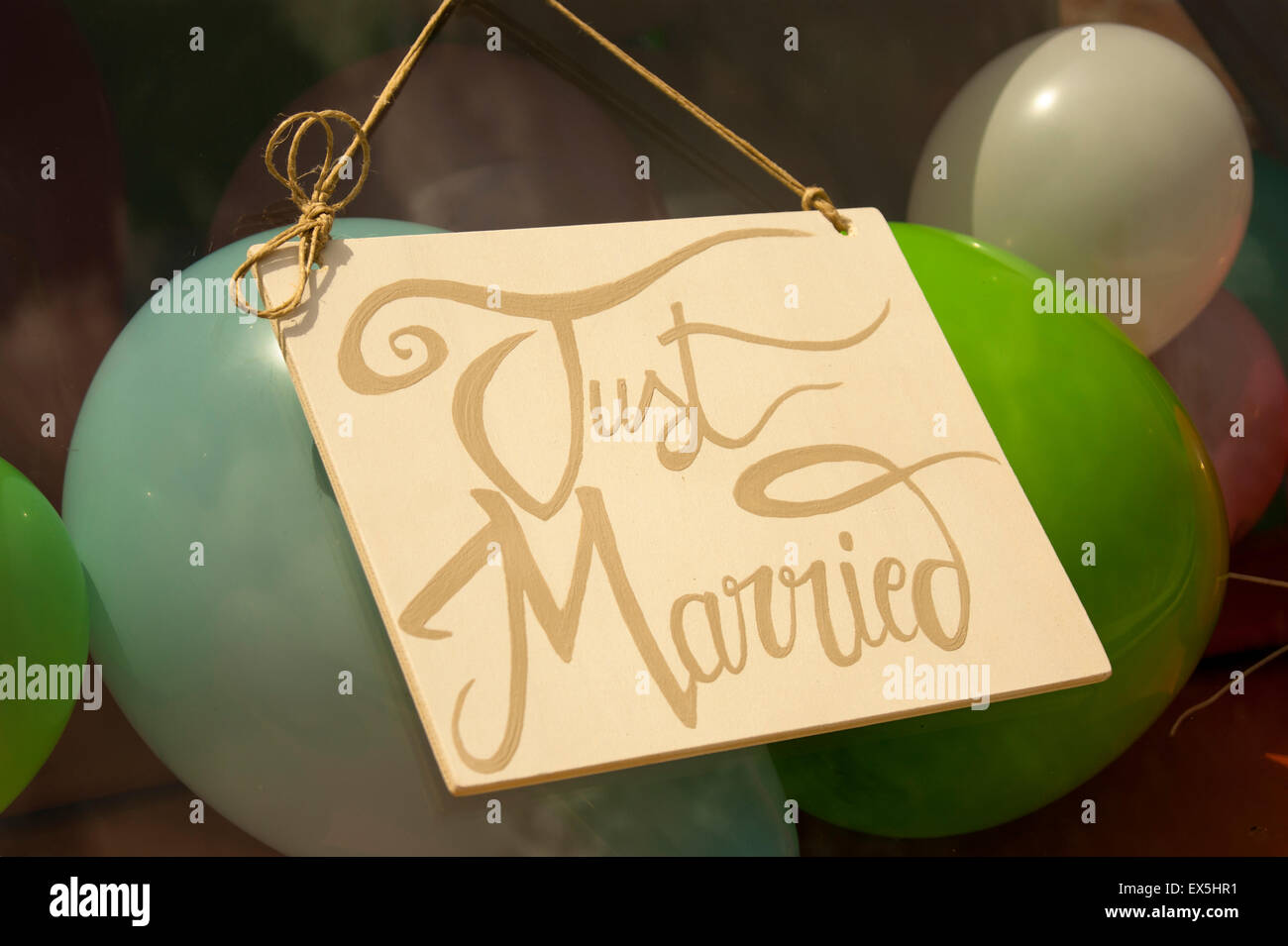 Just Married sign hand painted on wood, decorated with colored balloons ...