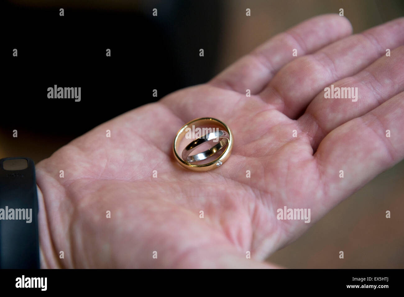 Wedding rings displayed on a hand Stock Photo - Alamy