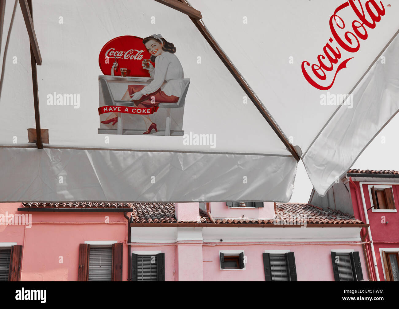 Retro style Coca Cola advert on a canopy with colourful houses in ...