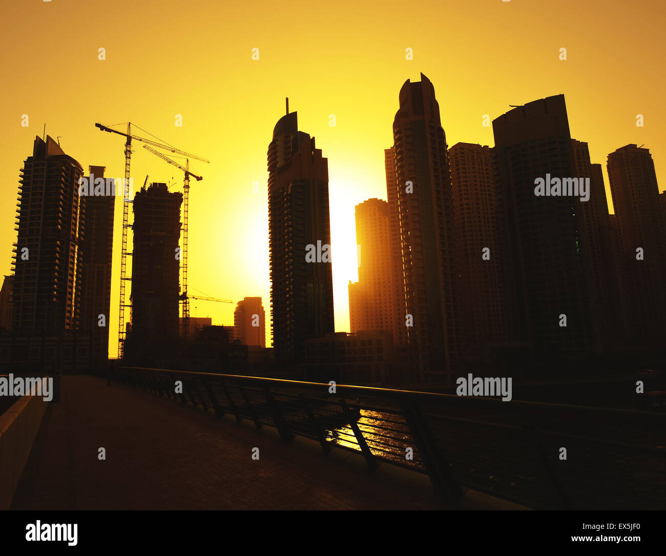 Modern city growing up, Construction with crane Stock Photo - Alamy