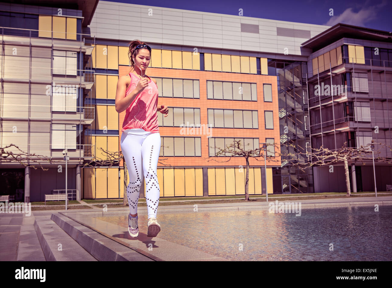 A young woman jogging in the city Stock Photo - Alamy
