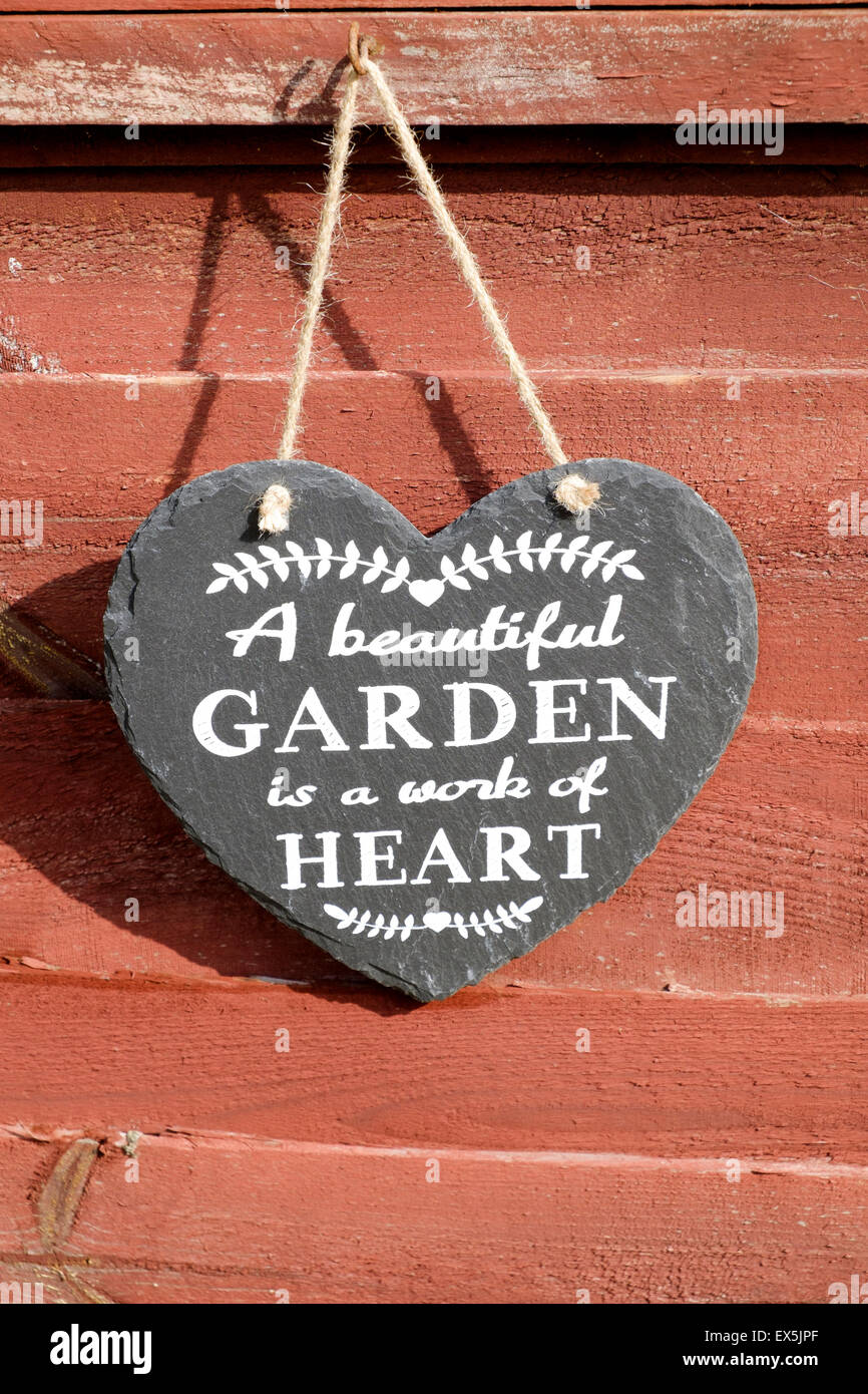 Garden decoration sign hanging by string on wooden structure Stock ...