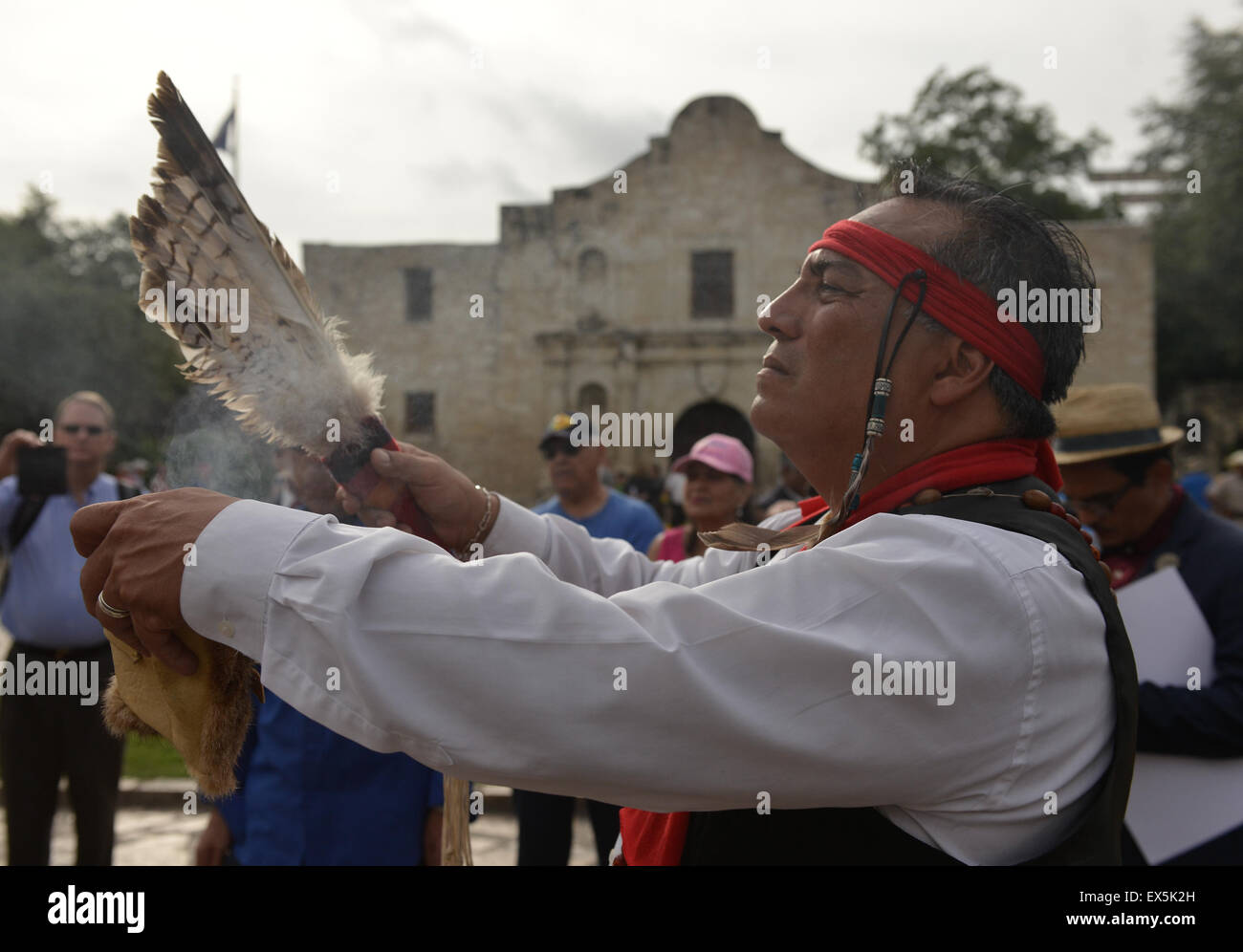 American Indian Adrian Ramirez sages the air and earth in front of San ...