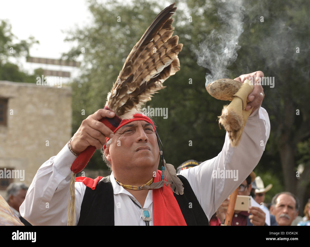 American Indian Adrian Ramirez sages the air and earth in front of San ...