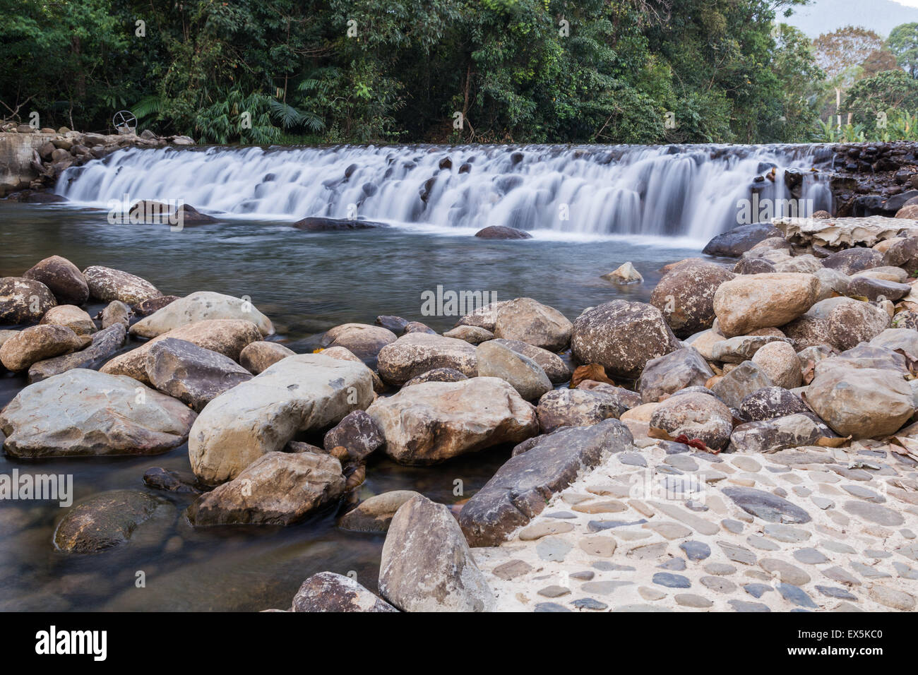 Dam handmade with stones A small river Stock Photo - Alamy