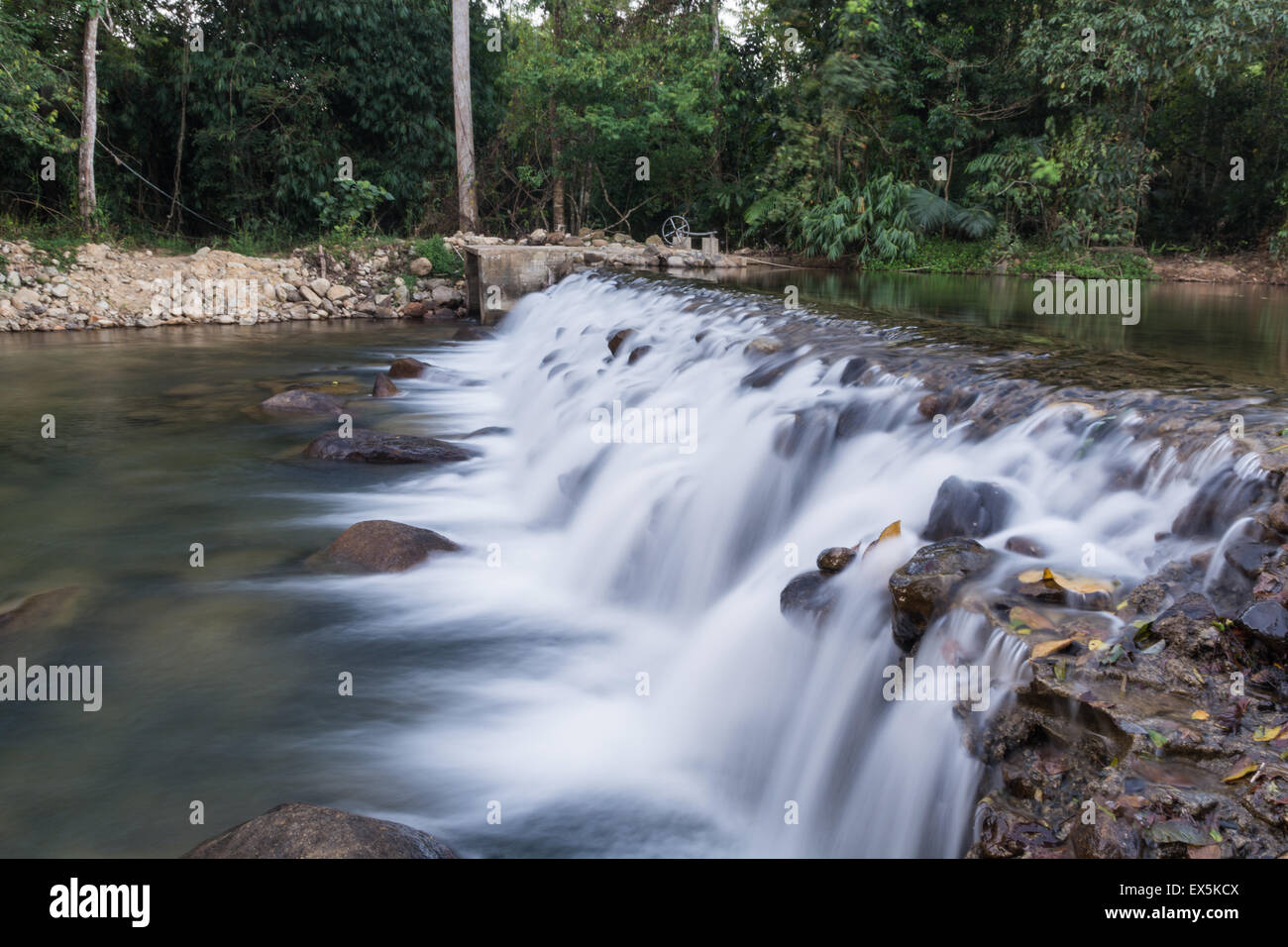 Dam handmade with stones A small river Stock Photo - Alamy