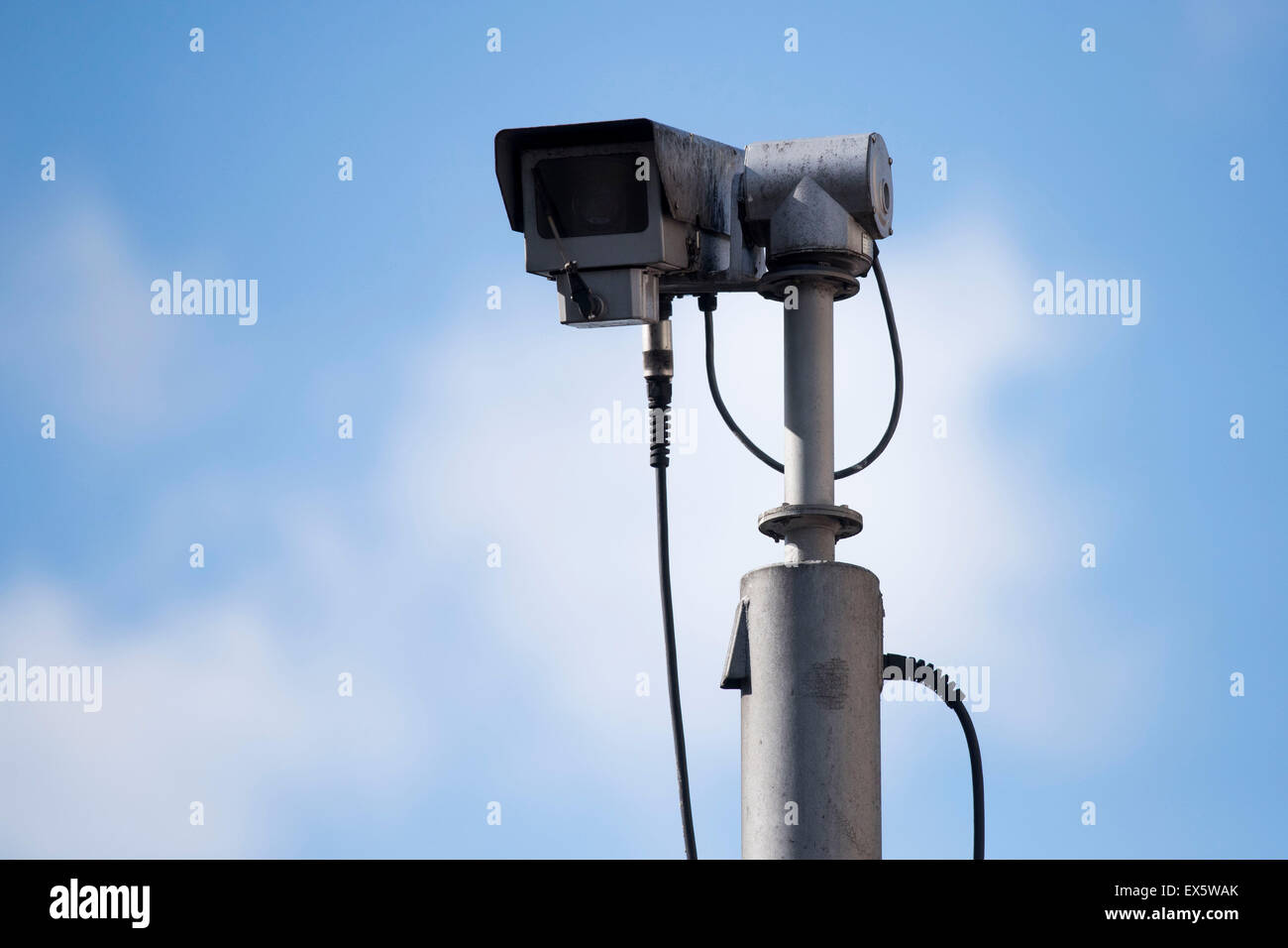 A CCTV camera with a blue sky behind Stock Photo - Alamy