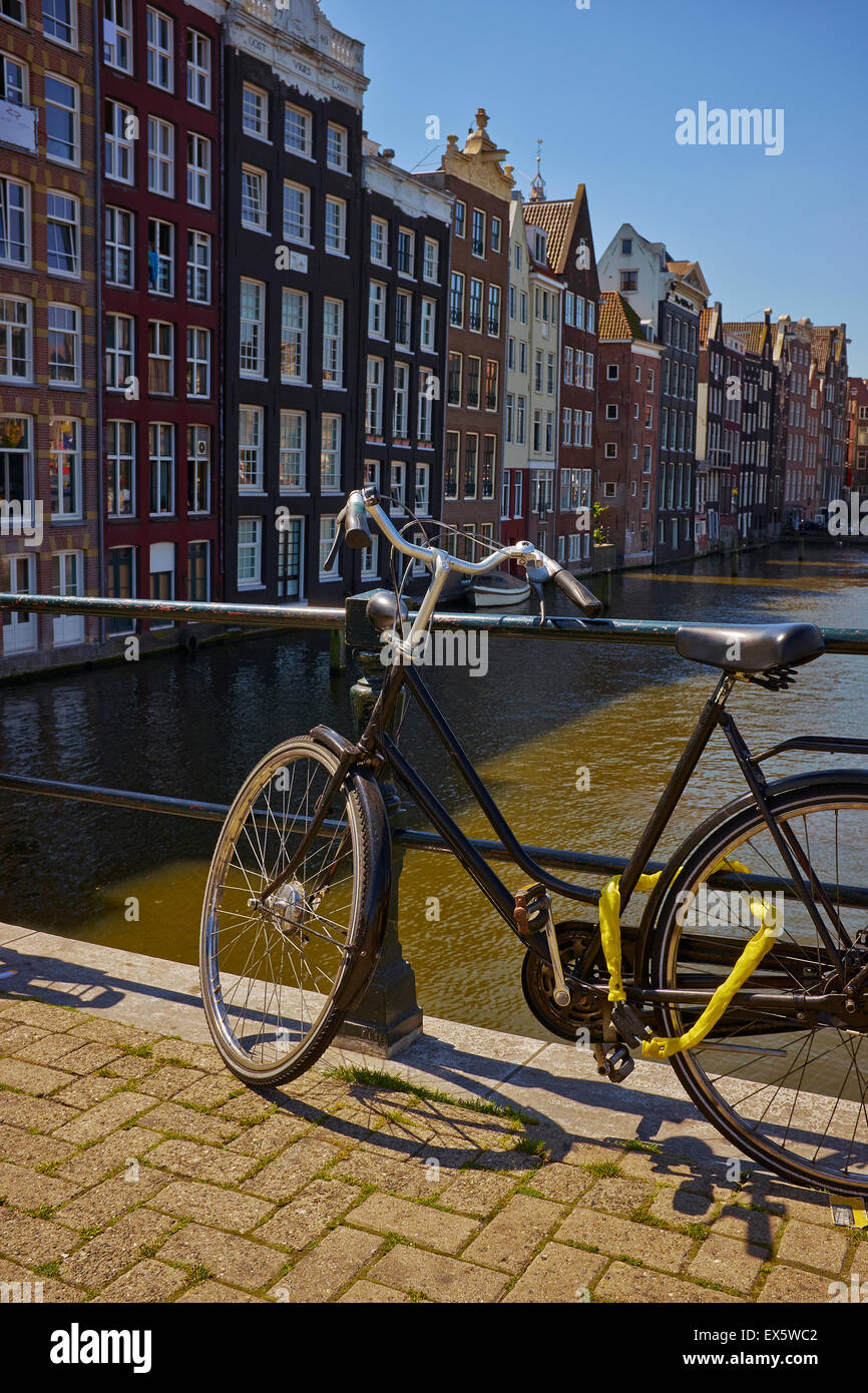 Historic canalside buildings in Damrak, Central Amsterdam, Netherlands ...