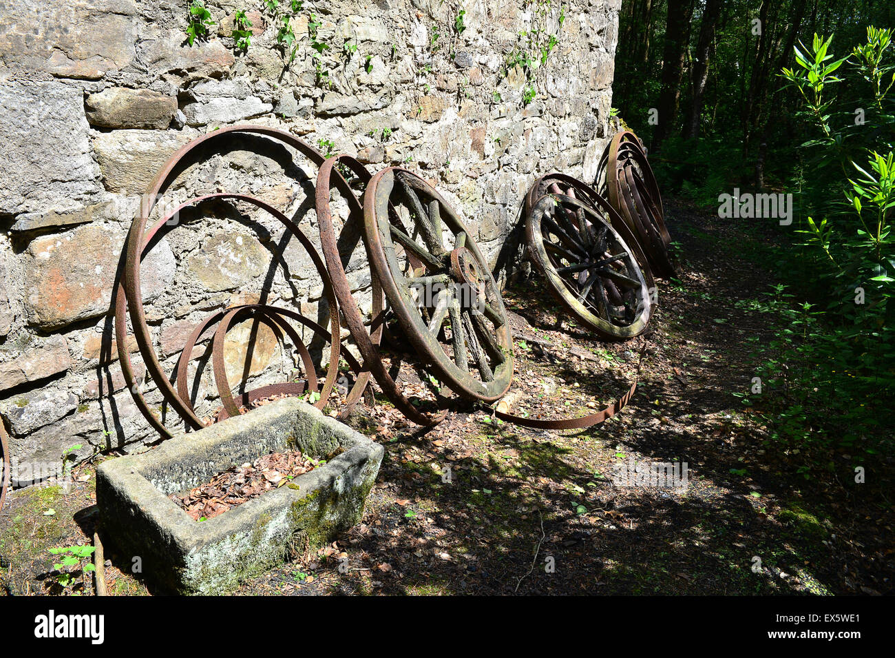 Old cart wheels at side of blacksmith's forge in the Ulster American ...