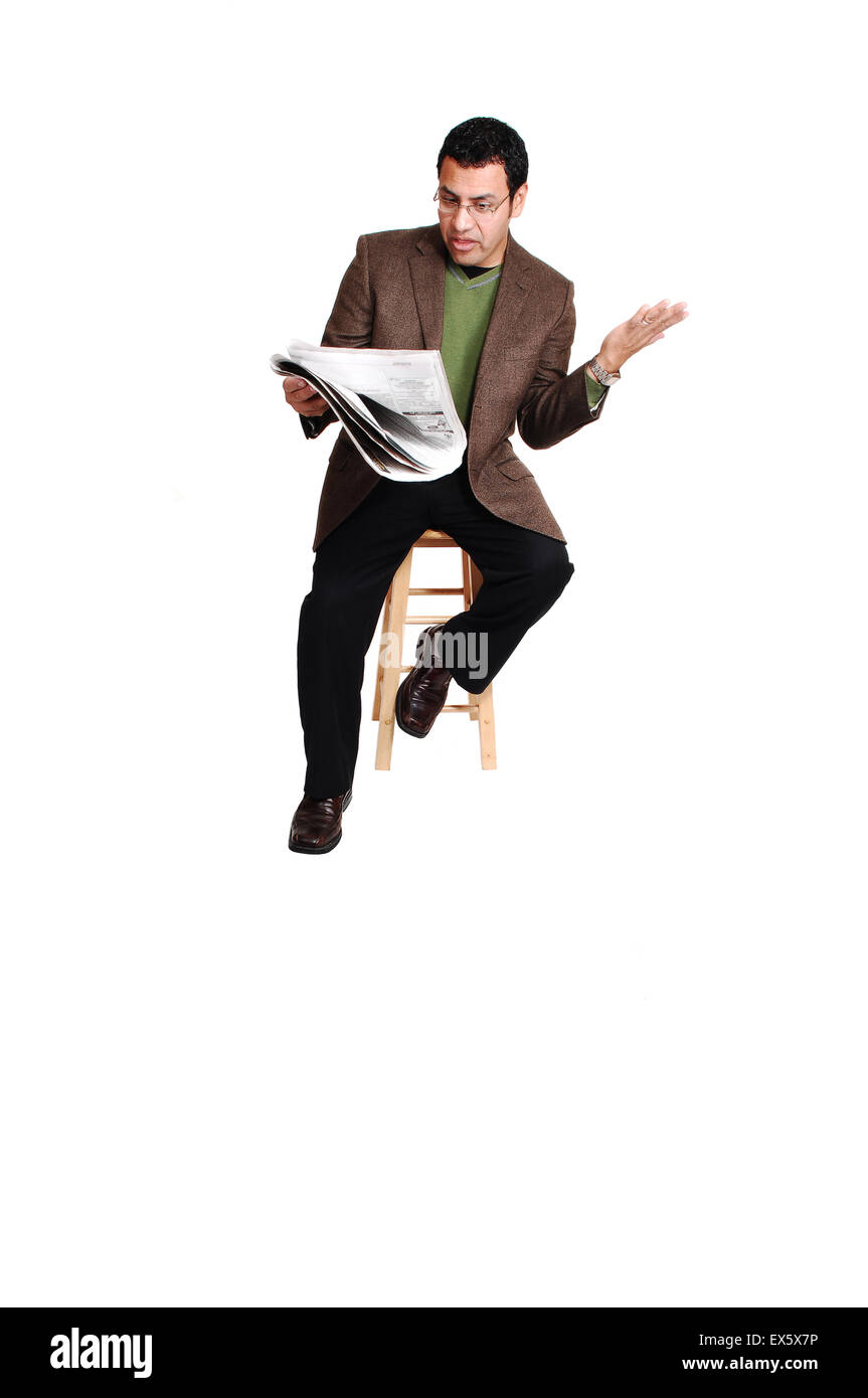 An middle ages man sitting and reading the newspaper in dress pants and ...